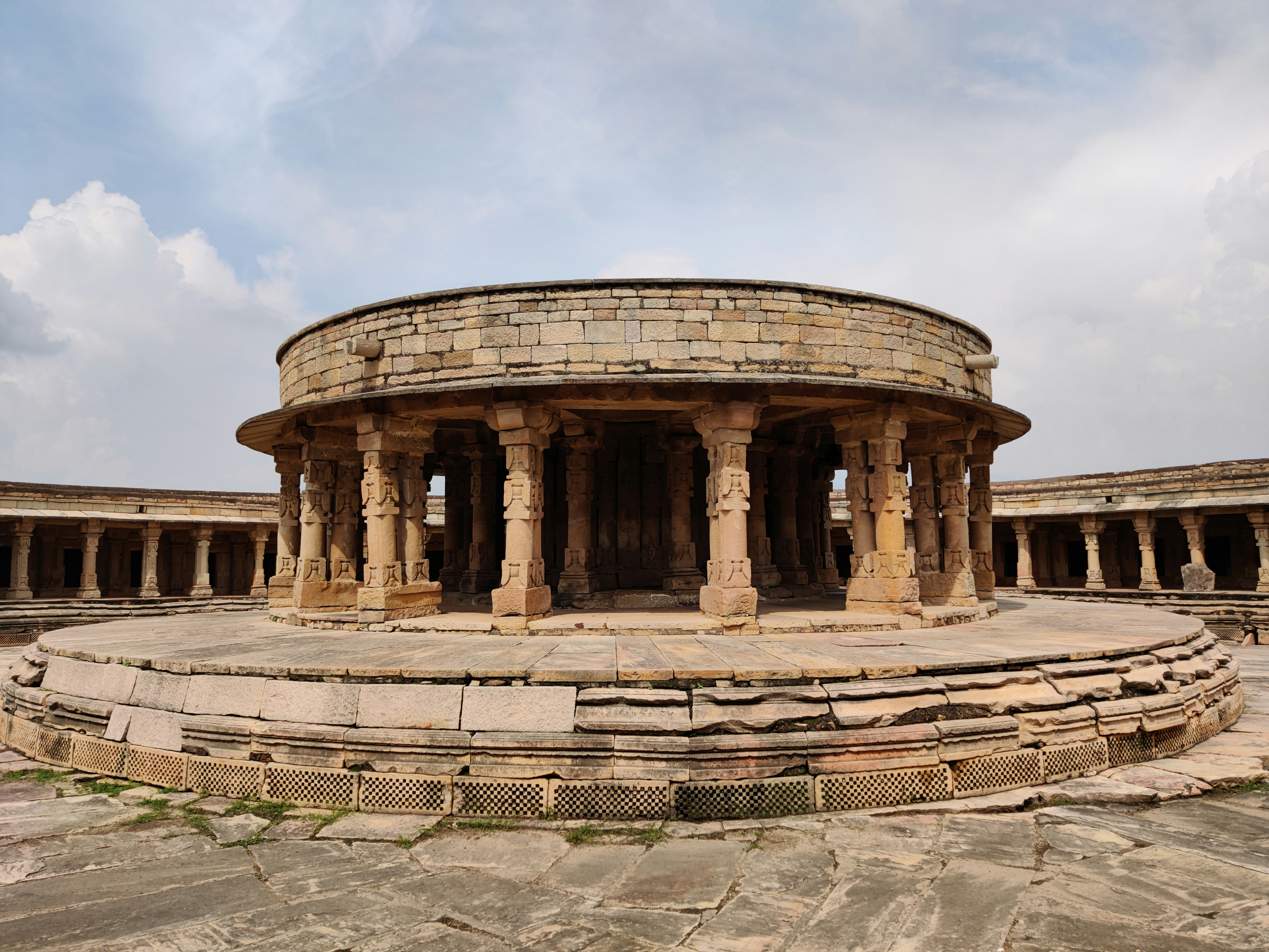 A circular building with pillars and pillars around it photo – Free ...