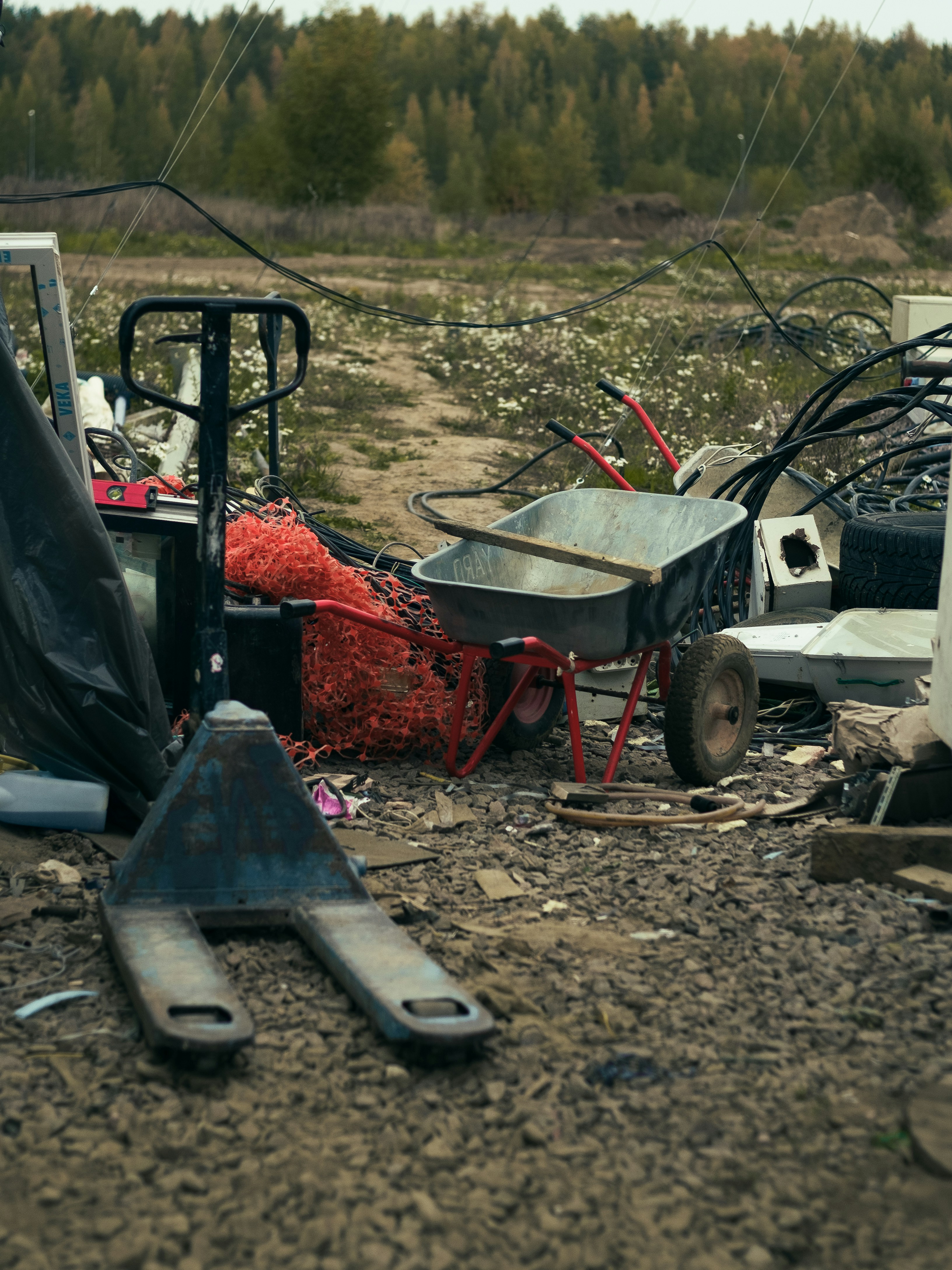 A pile of junk sitting on top of a dirt field photo – Free ...