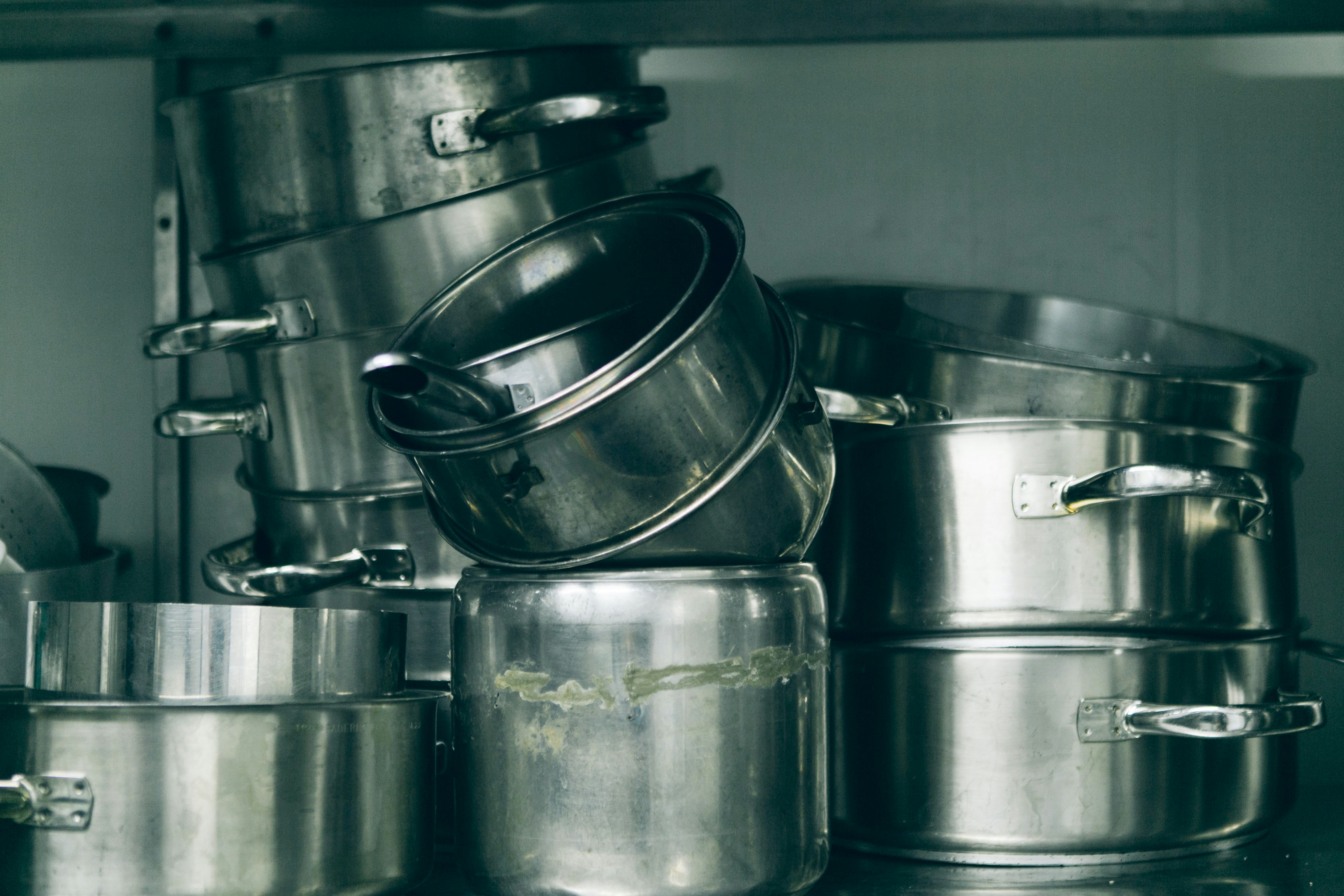 A bunch of pots and pans stacked on top of each other photo – Free ...