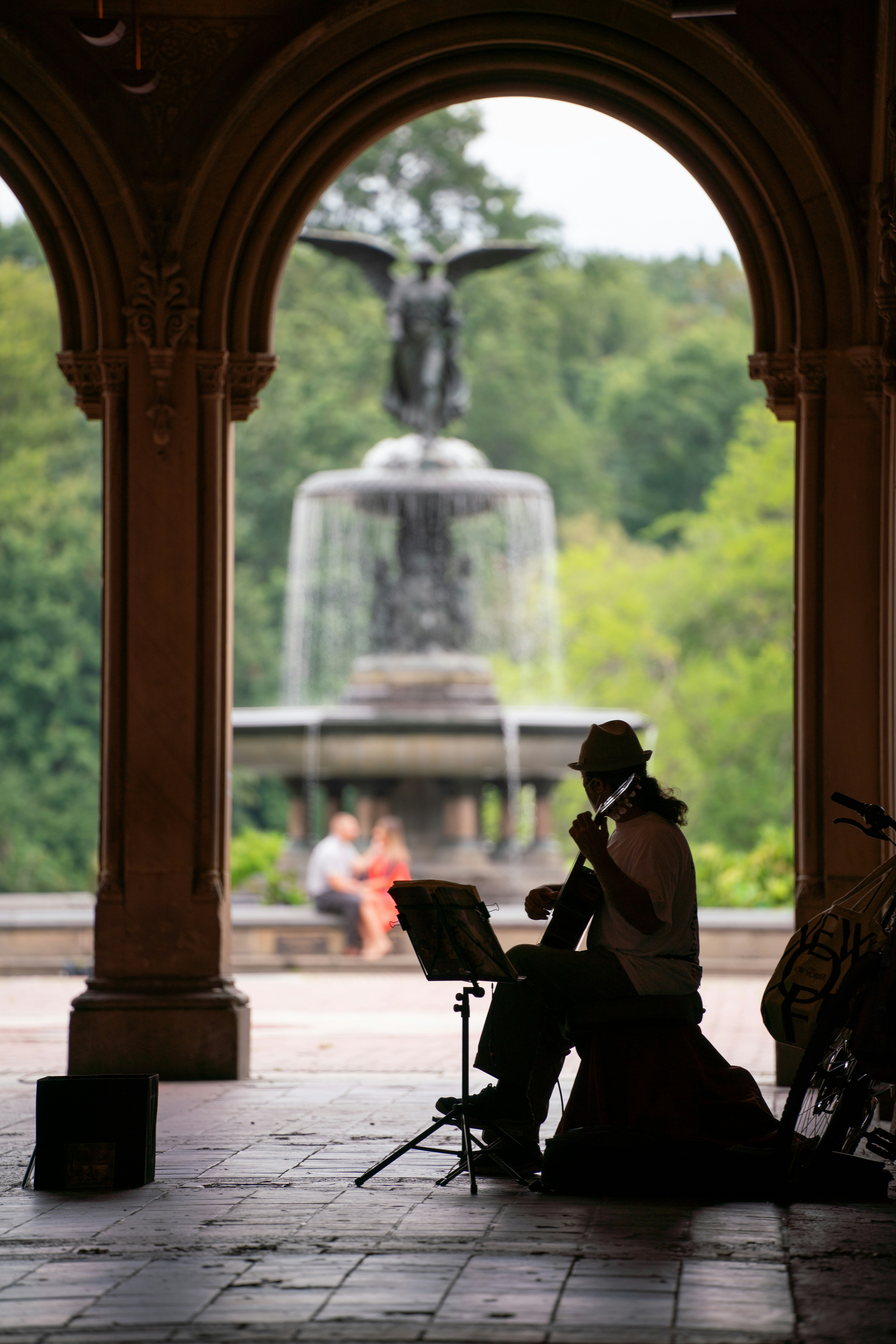 Underarched Silence: A Street Musician in the Fountain Arch