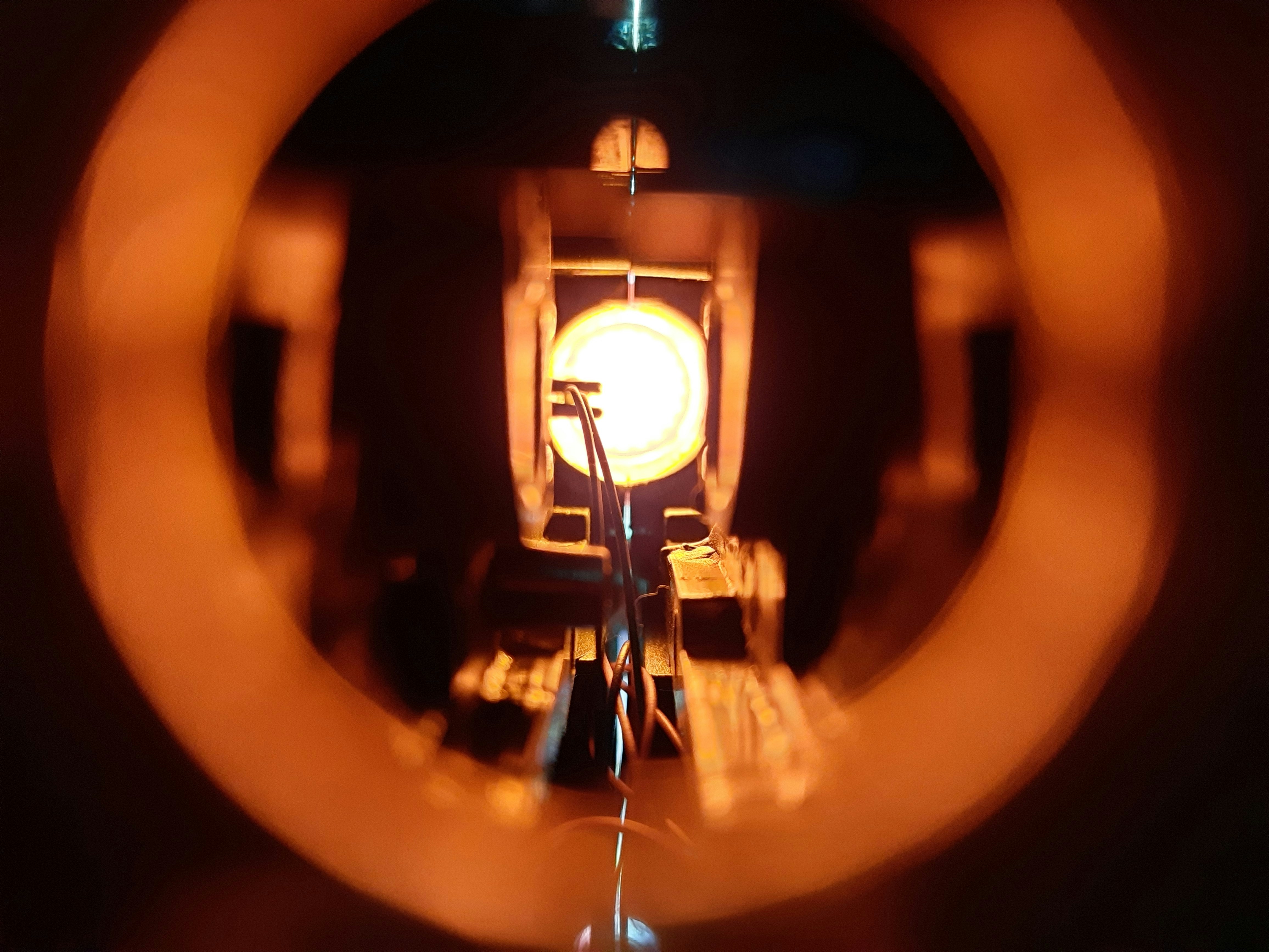 Inside the Ring: a warm filament glow framed by a circular aperture