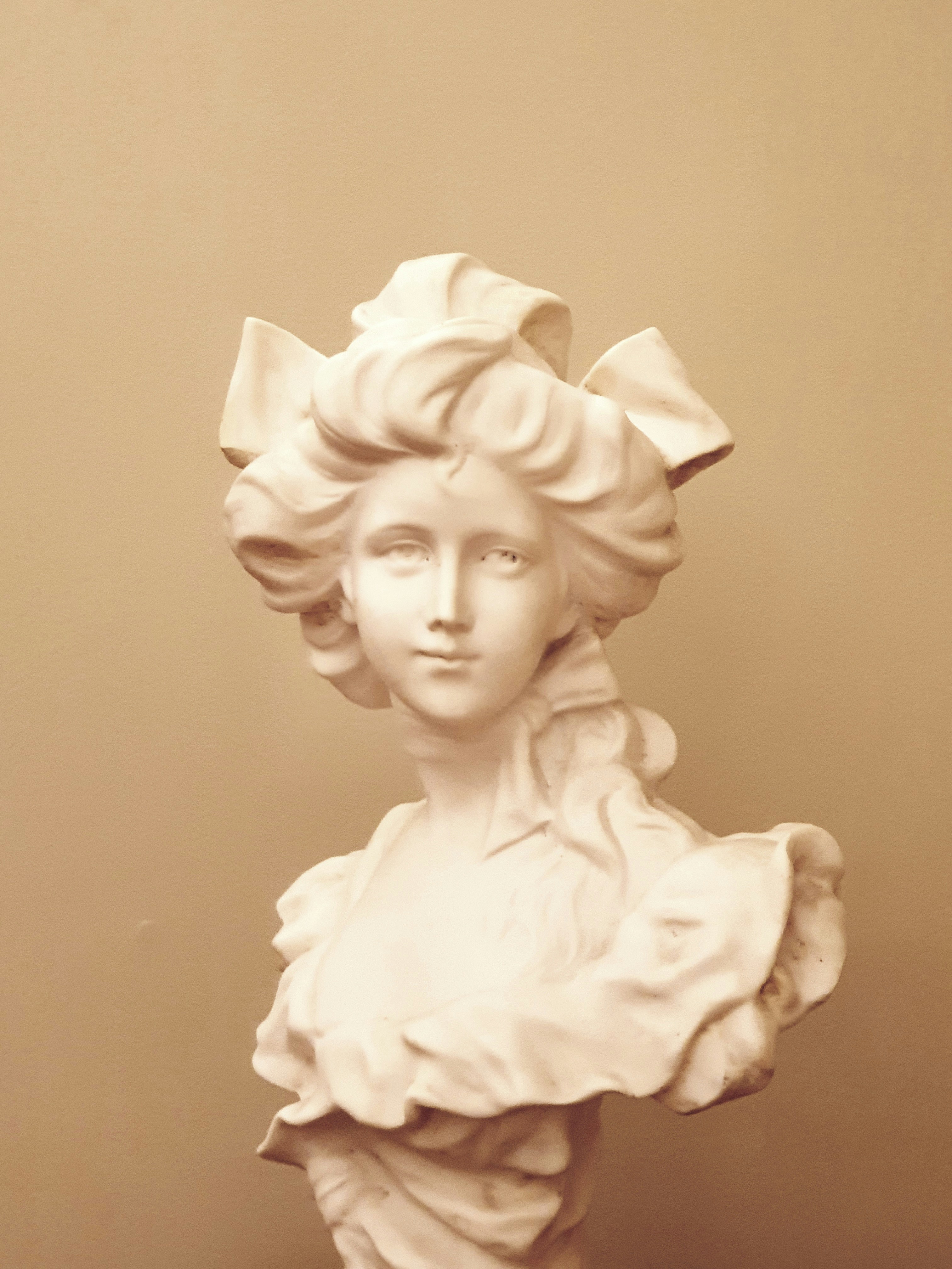 A statue of a woman with a flower in her hair photo – Free Art Image on ...