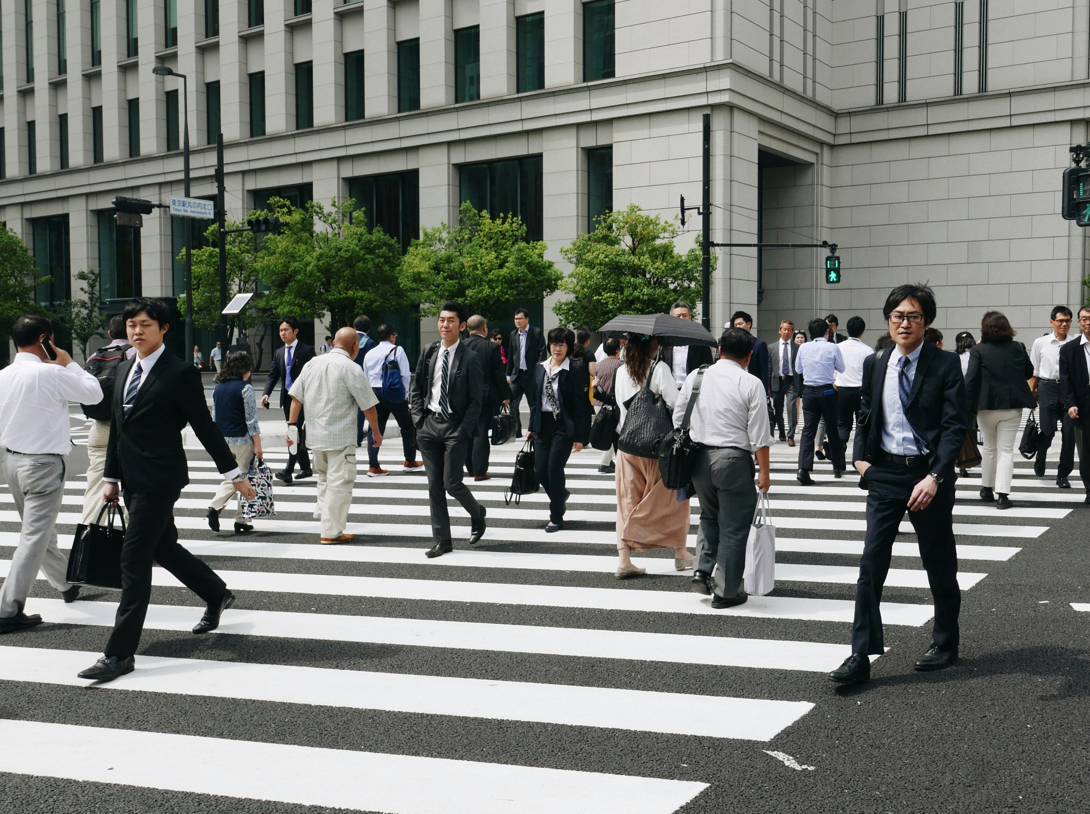 A group of people walking across a cross walk photo – Free Tokyo Image ...