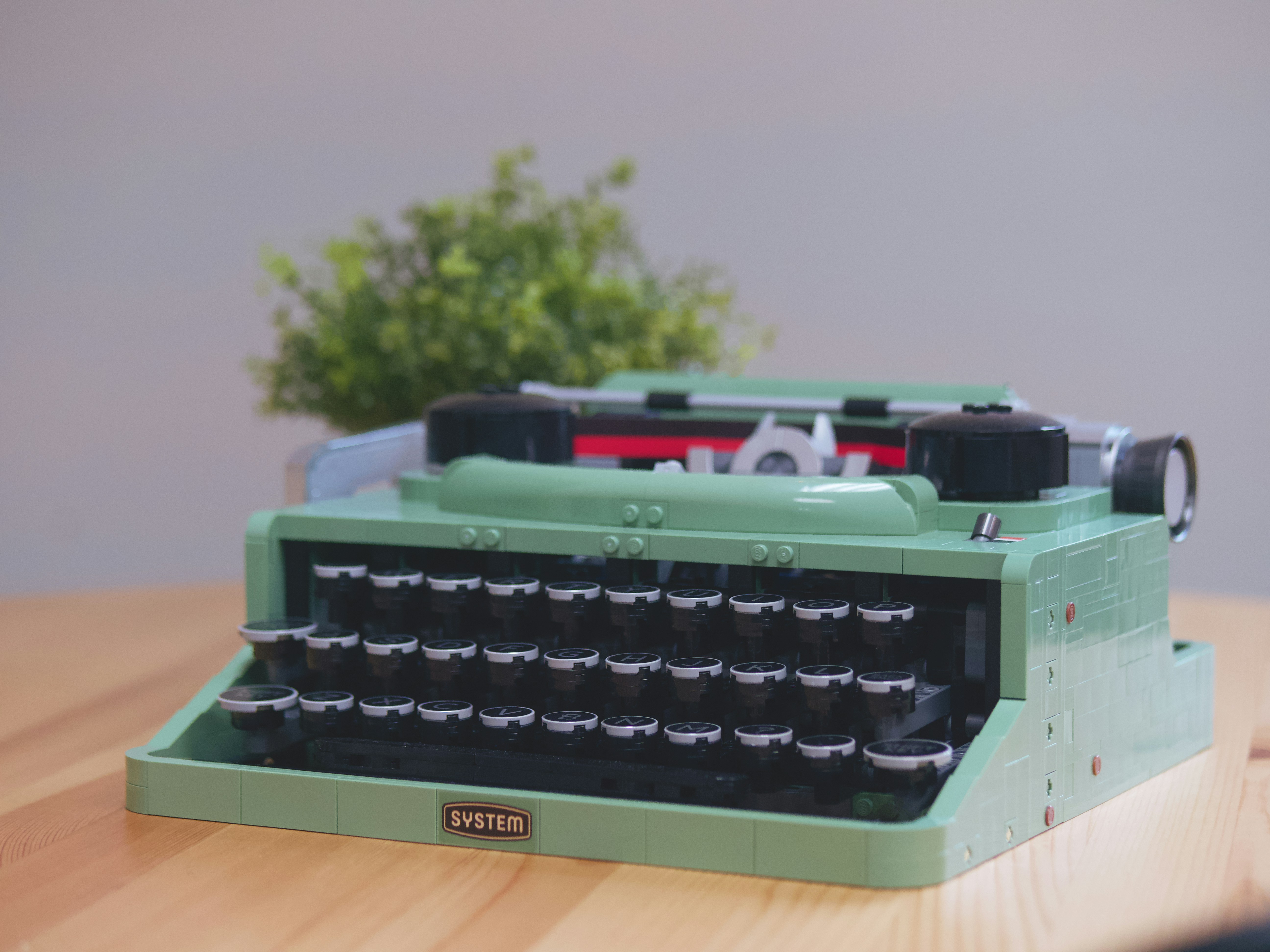 A green typewriter sitting on top of a wooden table photo – Free Grey ...