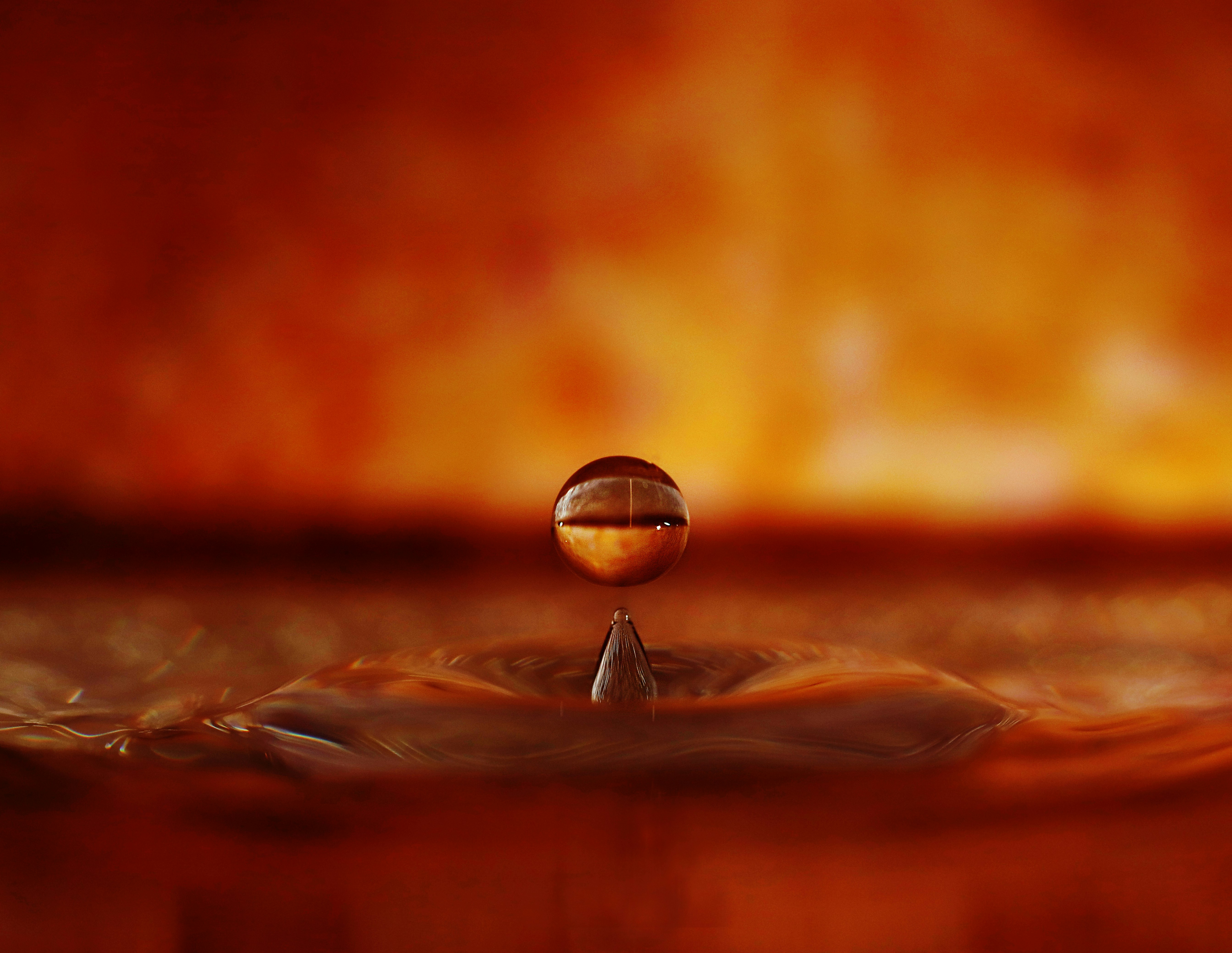 Amber Crown Over a Water Spike: macro capture of a lone droplet