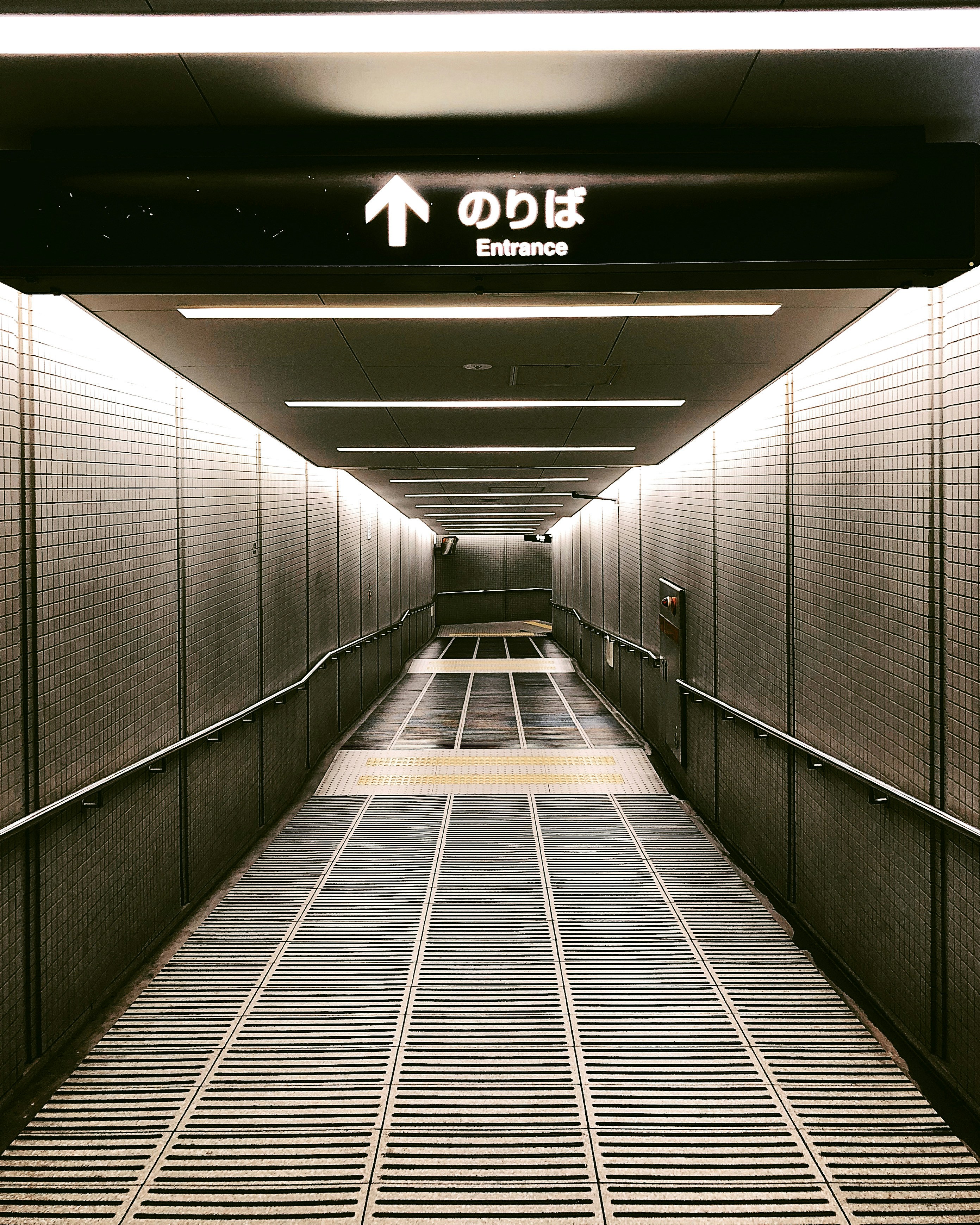 Underground Ascent: Neon Corridor to the Street