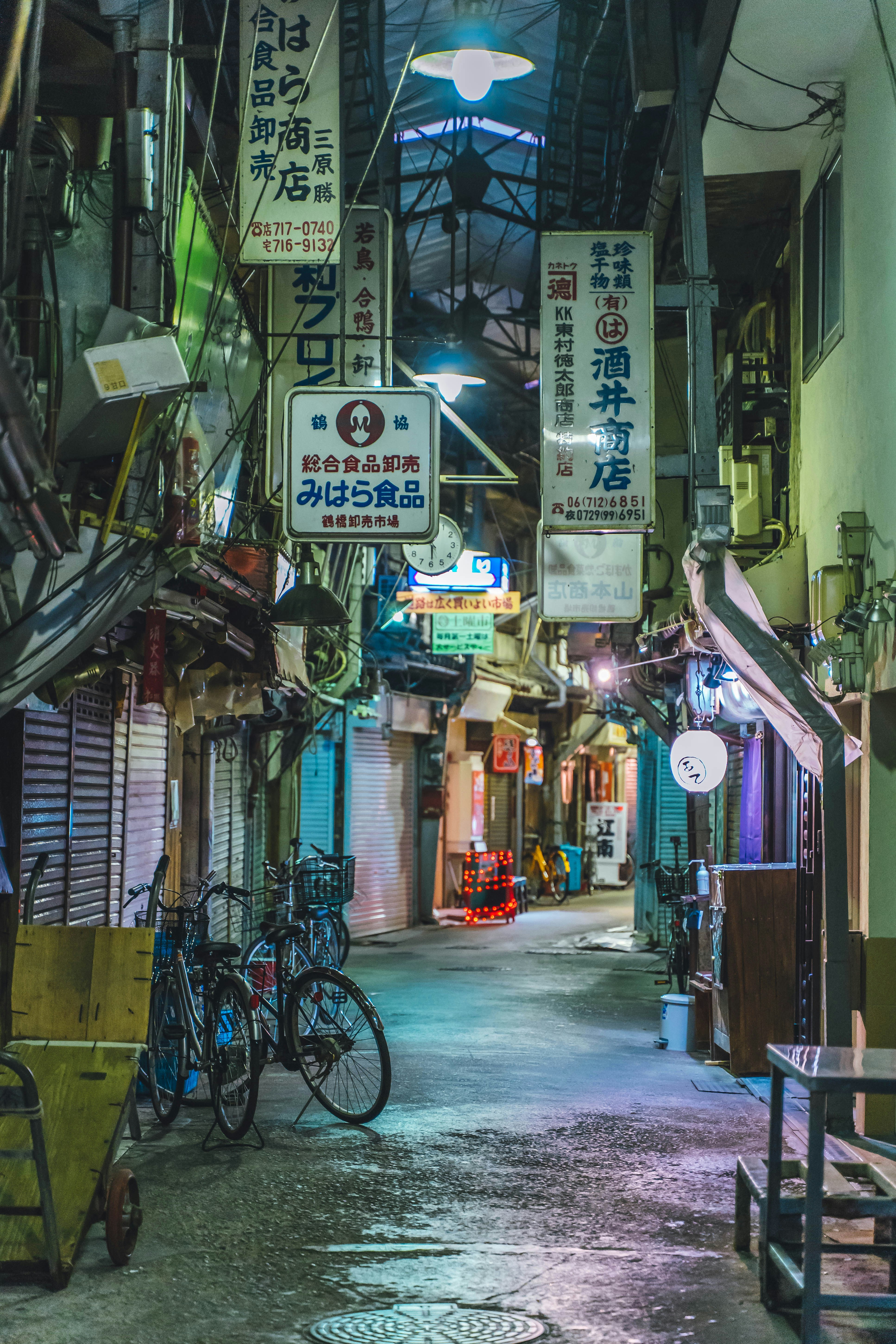 A narrow alley way with many signs hanging from the ceiling photo ...
