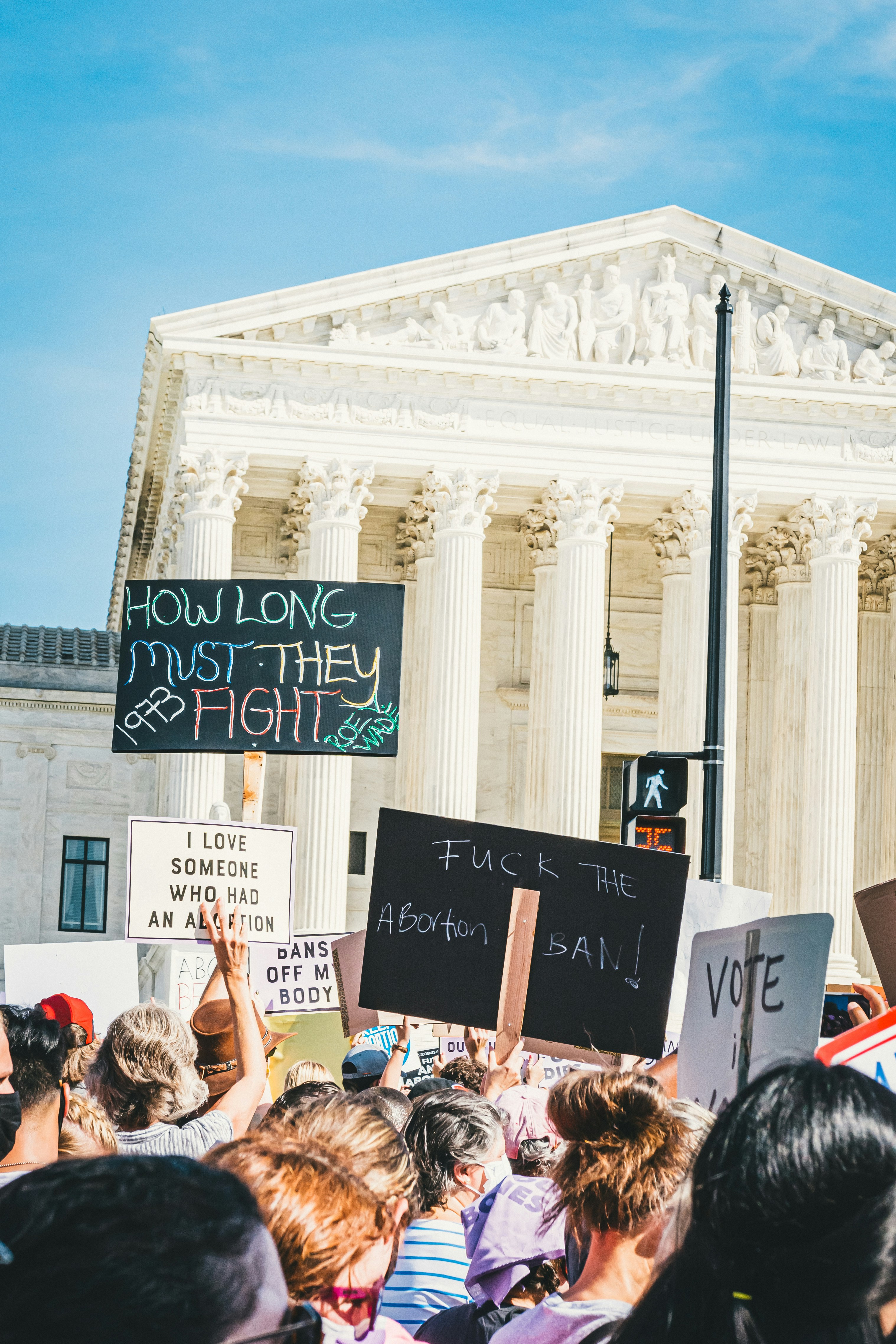 A group of people holding signs in front of a building photo – Free Dc ...