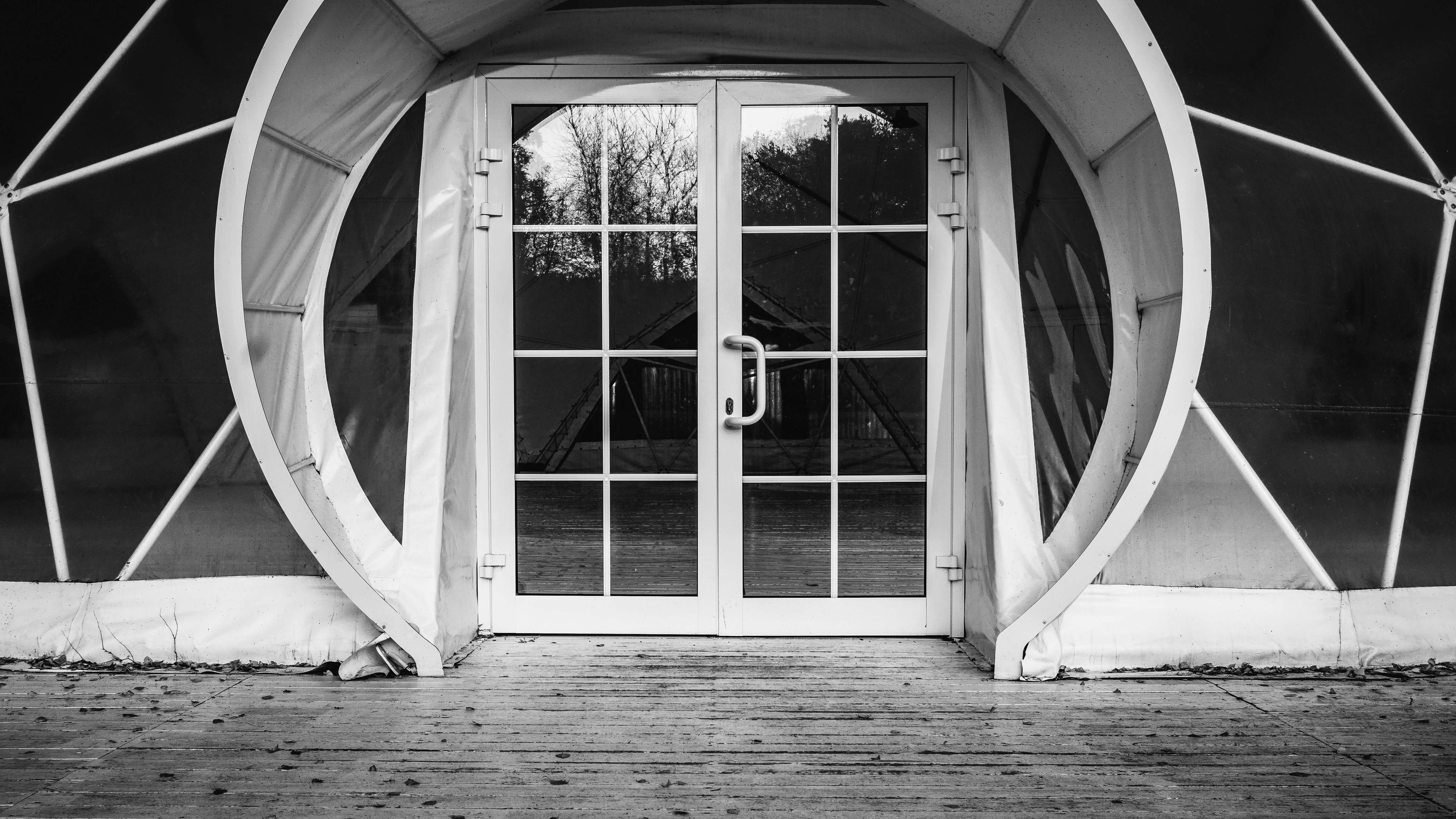 Symmetrical Portal: Central Glass Doors Framed by a Tunnel-Like Tent