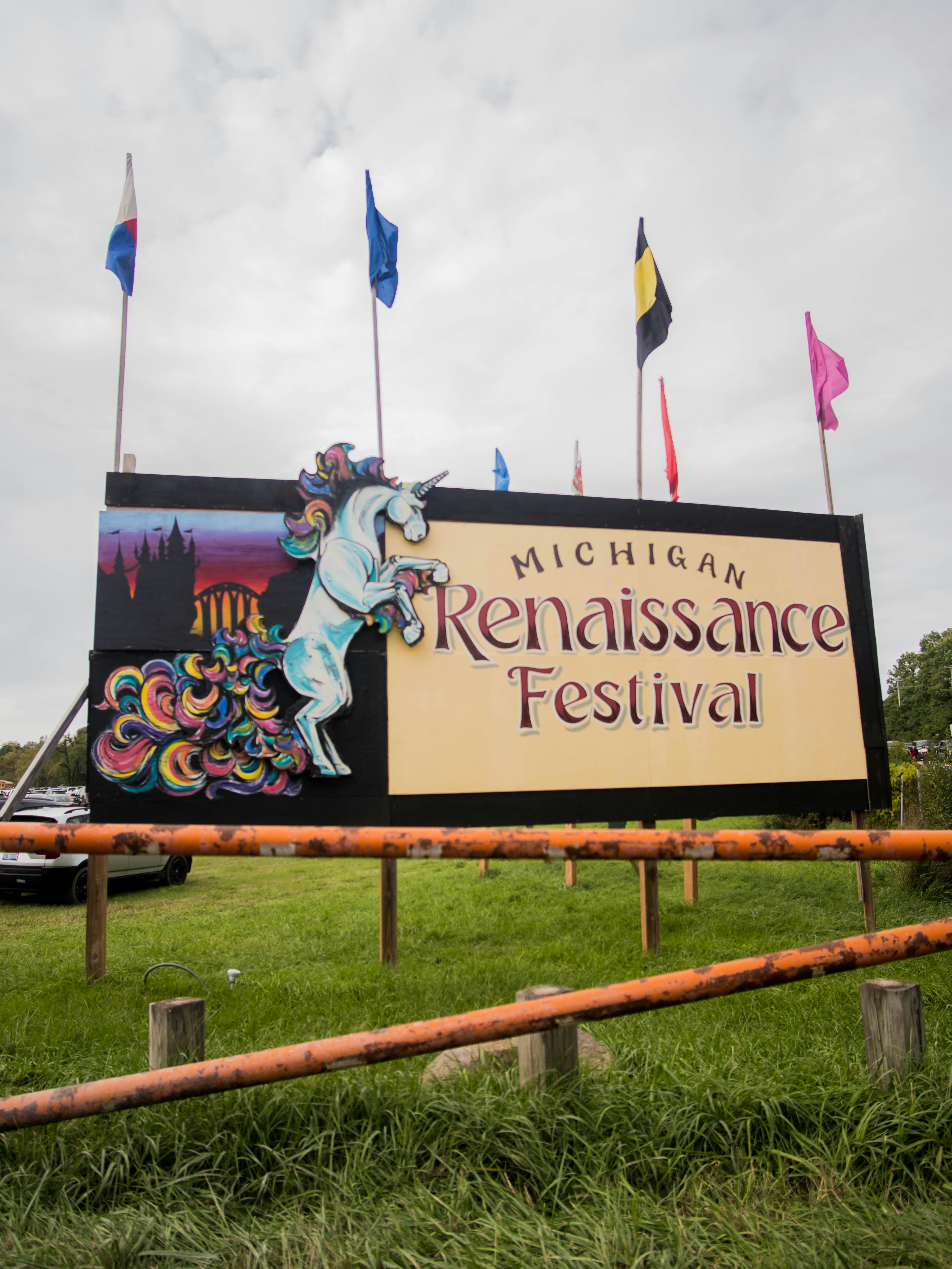 A sign for a renaissance festival in a field photo – Free Michigan ...