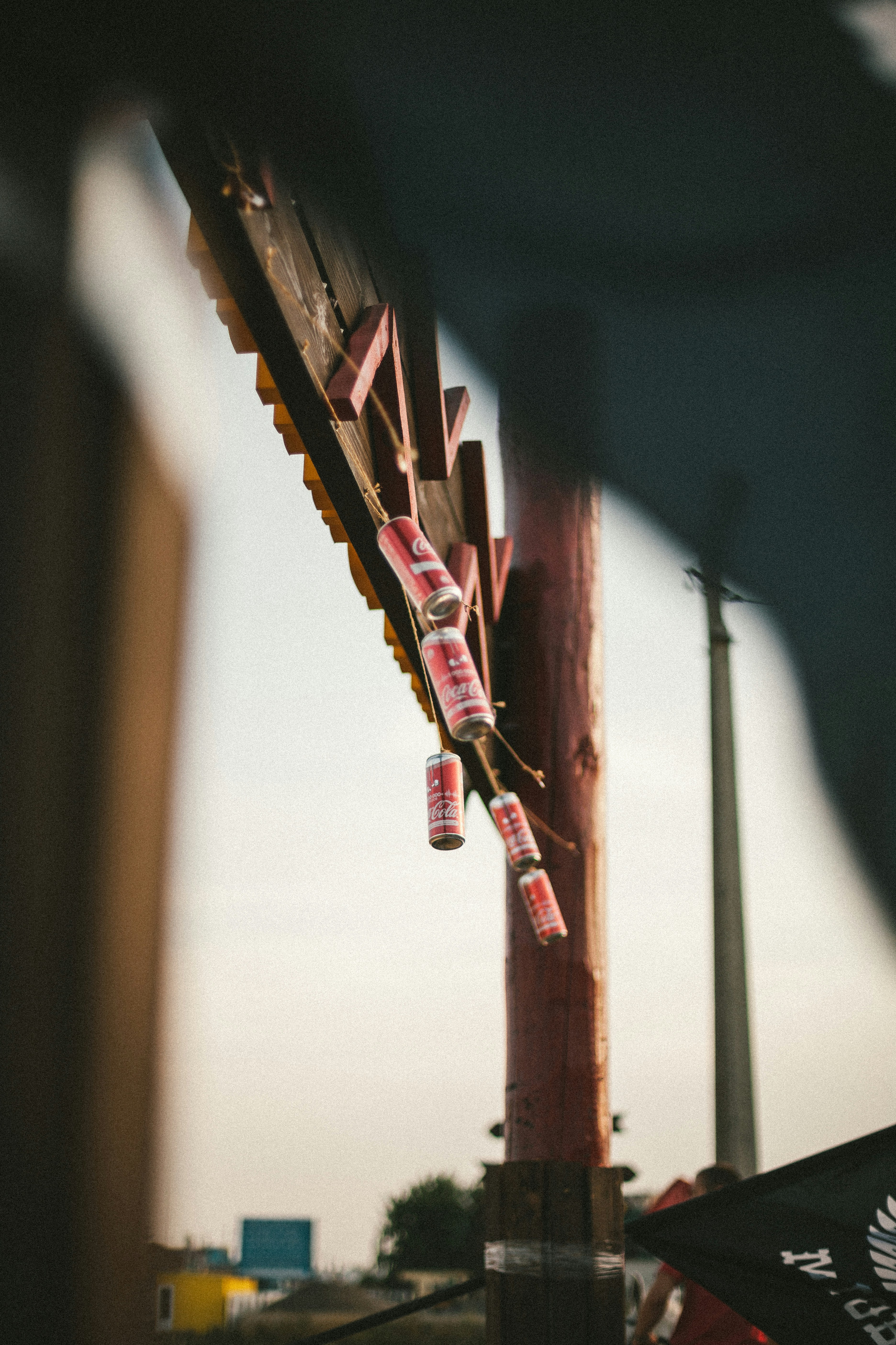 Dusk Chimes on a Weathered Post: Red Soda-Can OrnamentsAlexander Bennington