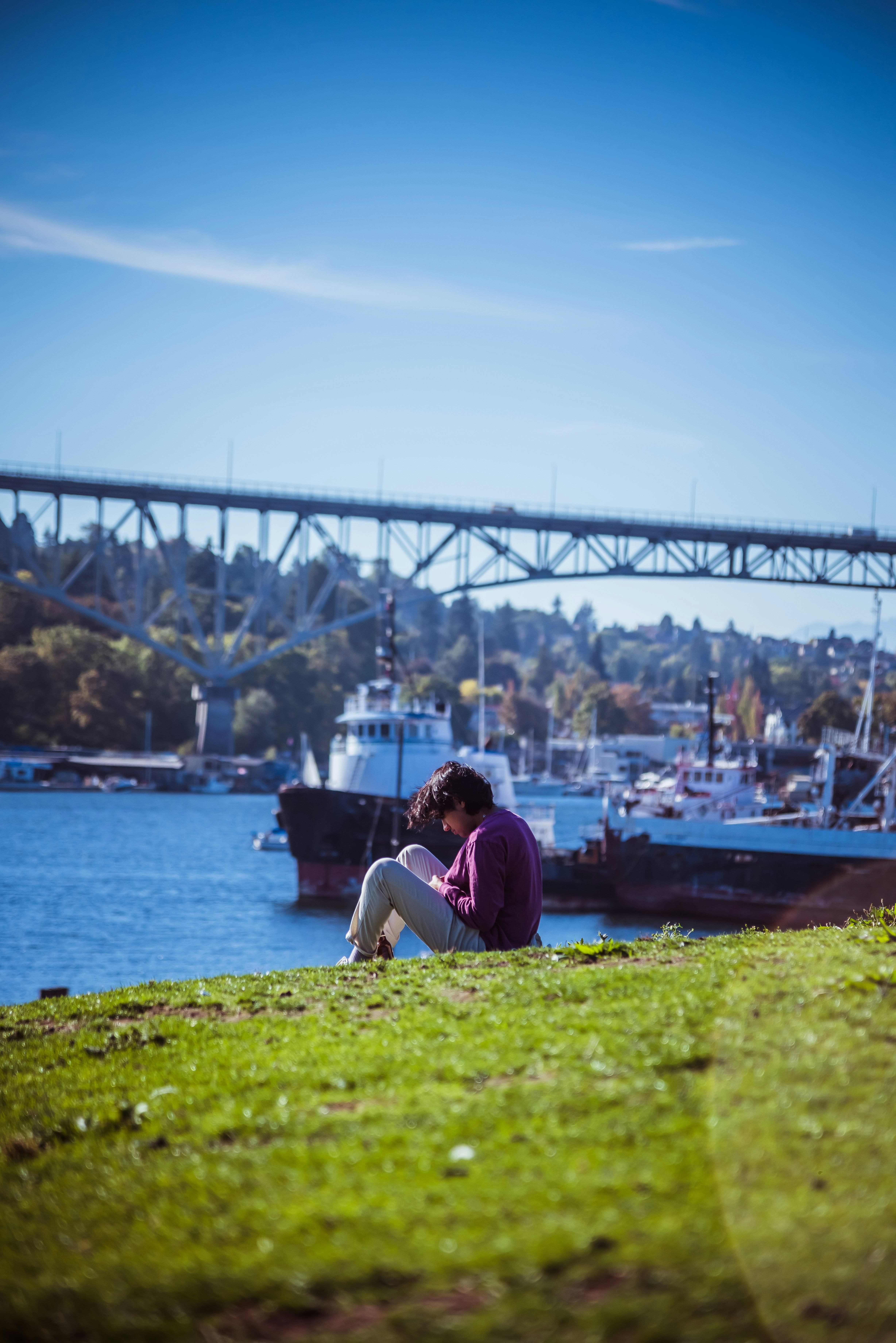 A Quiet Moment by the Water under a Distant Bridge