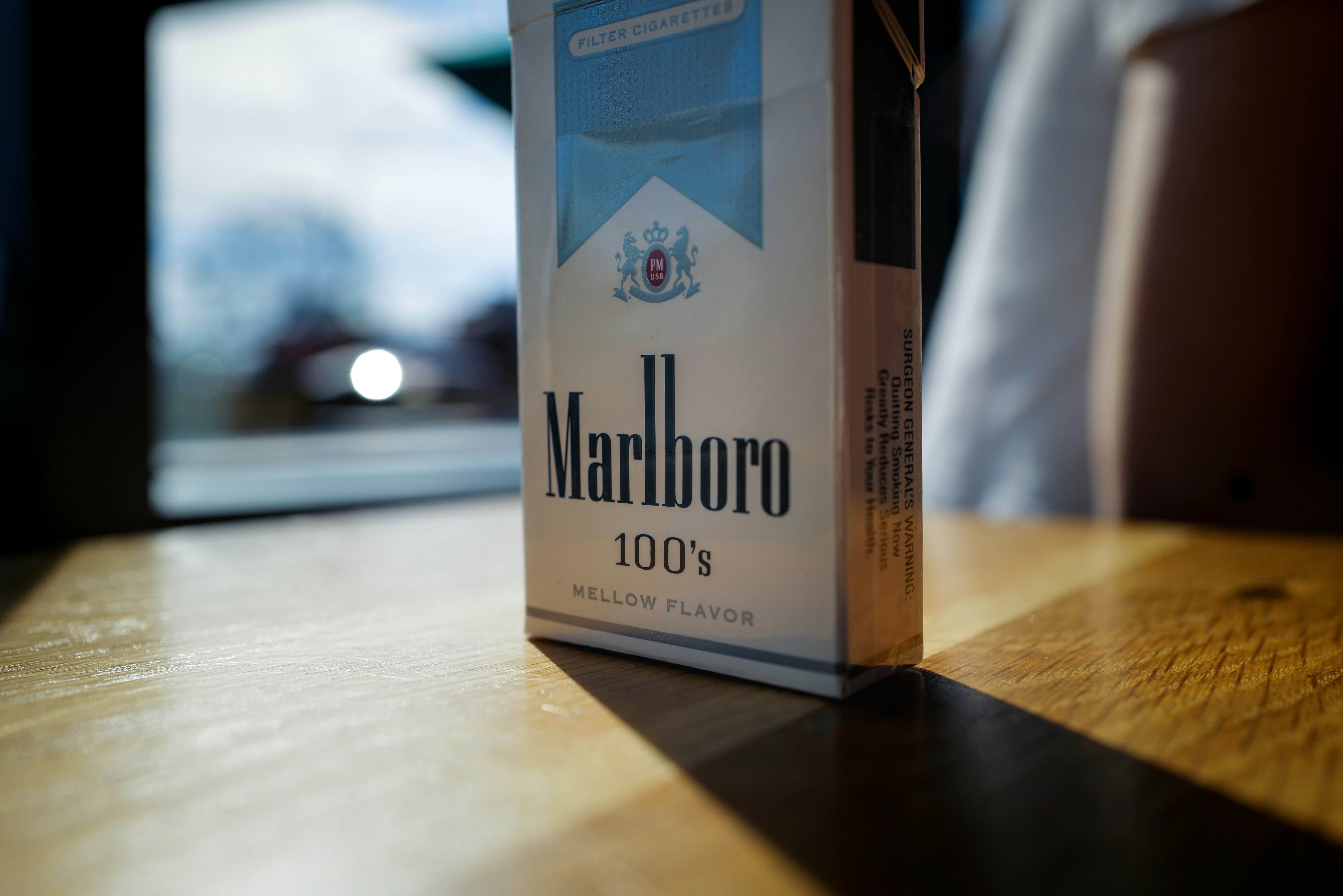 A box of marlboro sitting on top of a wooden table photo – Free Grey ...