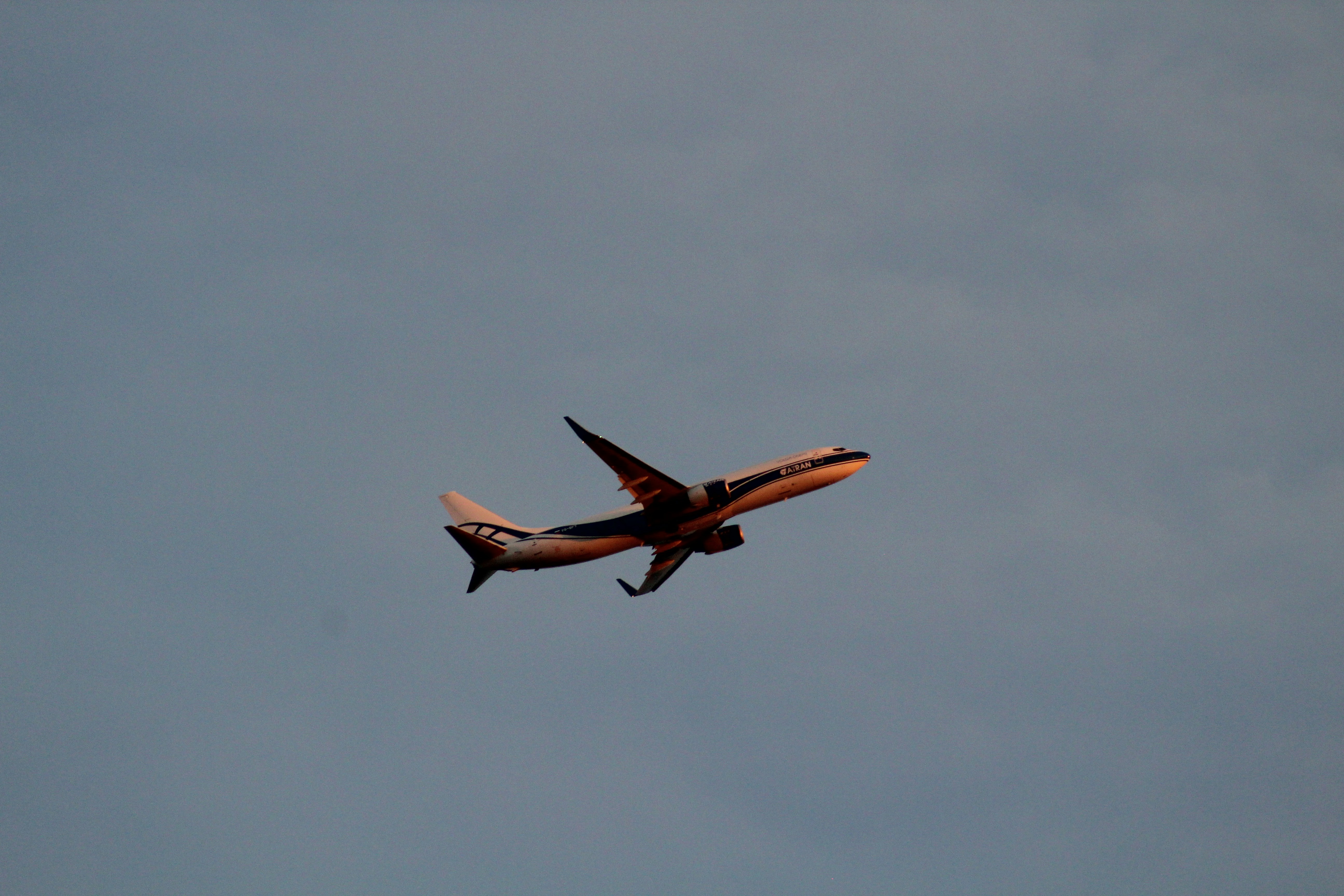 a large jetliner flying through a blue sky
