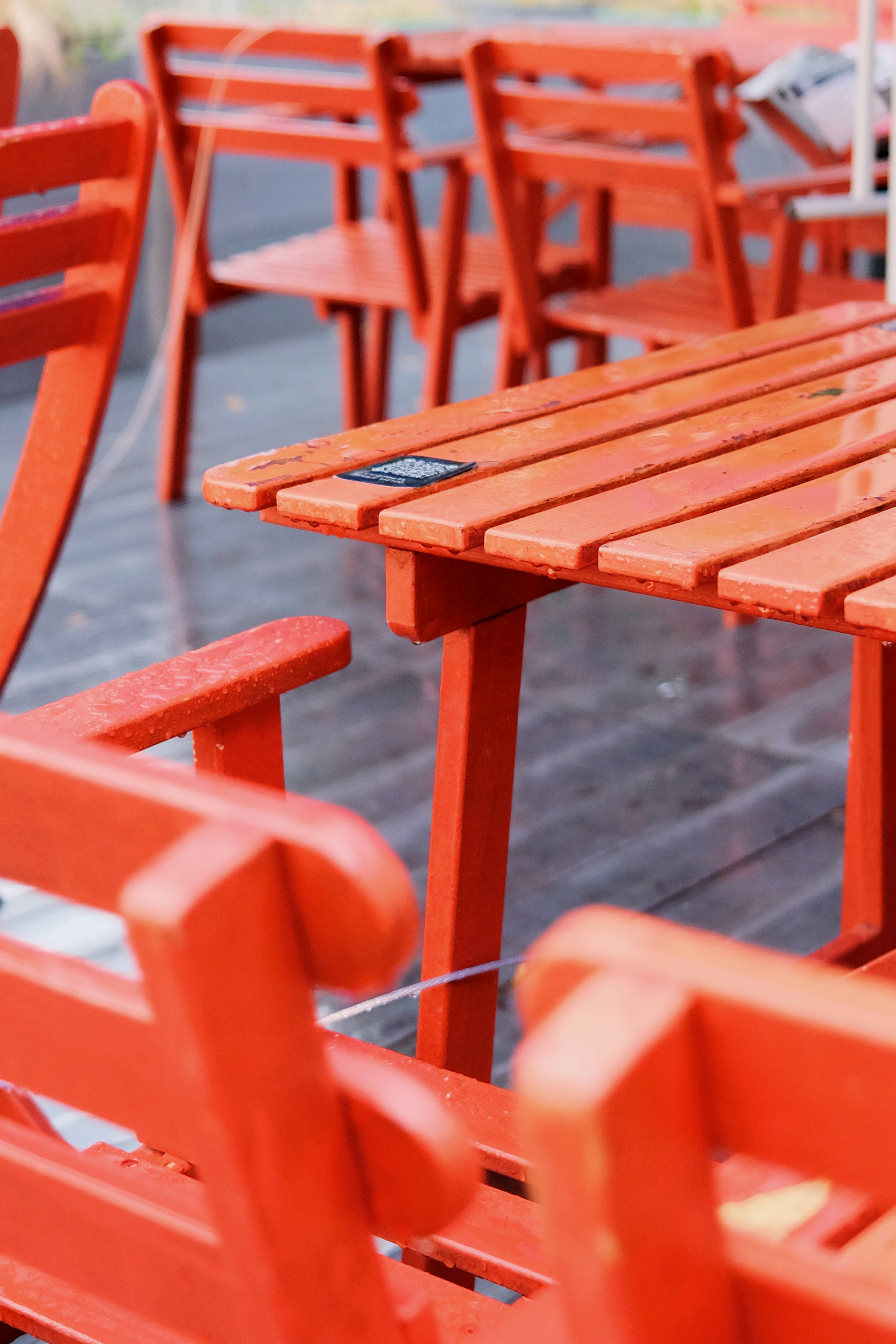 A row of red wooden benches sitting next to each other photo – Free ...