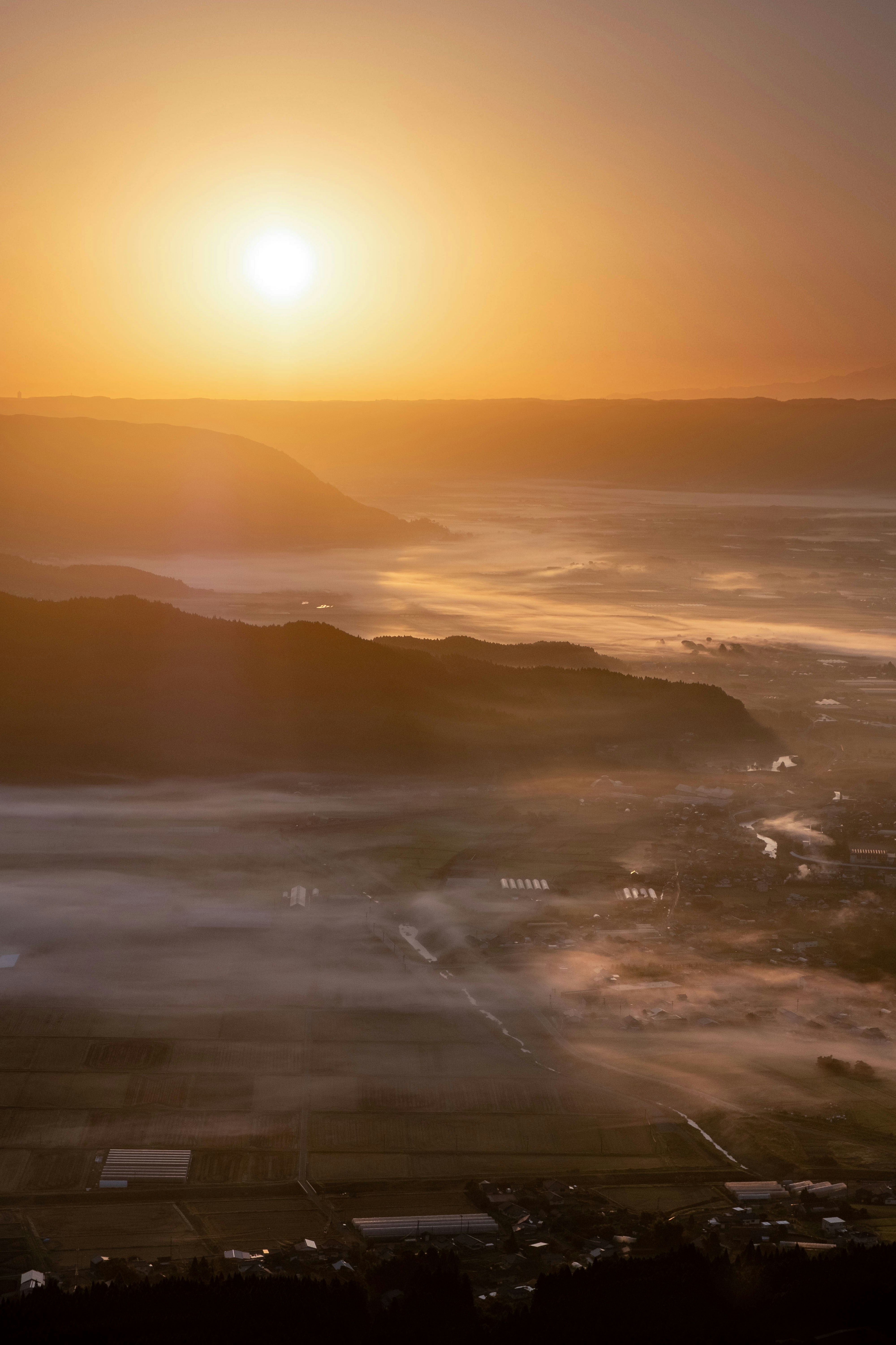 Dawn's Golden Veil: Mist-Lit Coastline at First Light