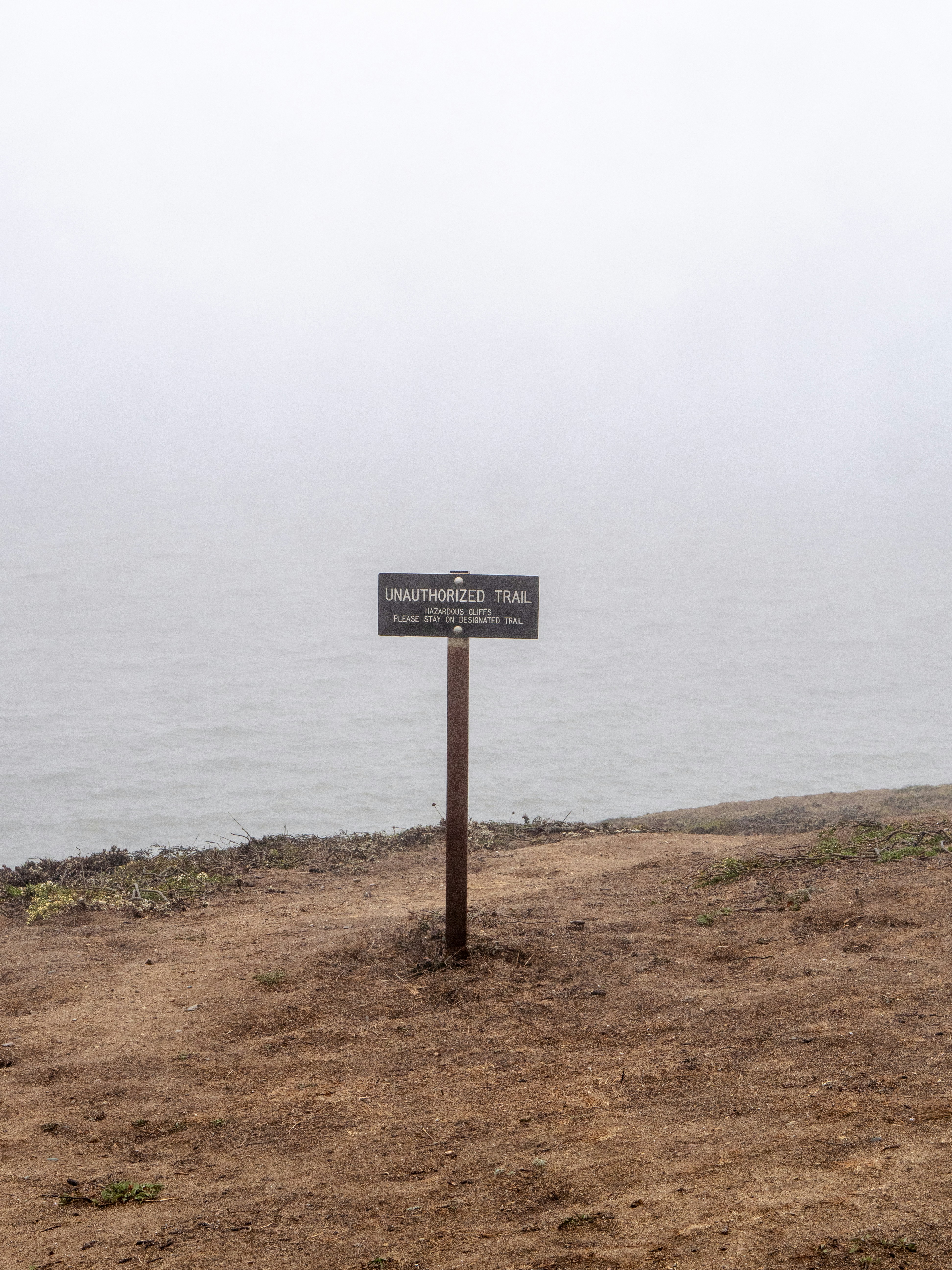 a sign that is on the side of a hill