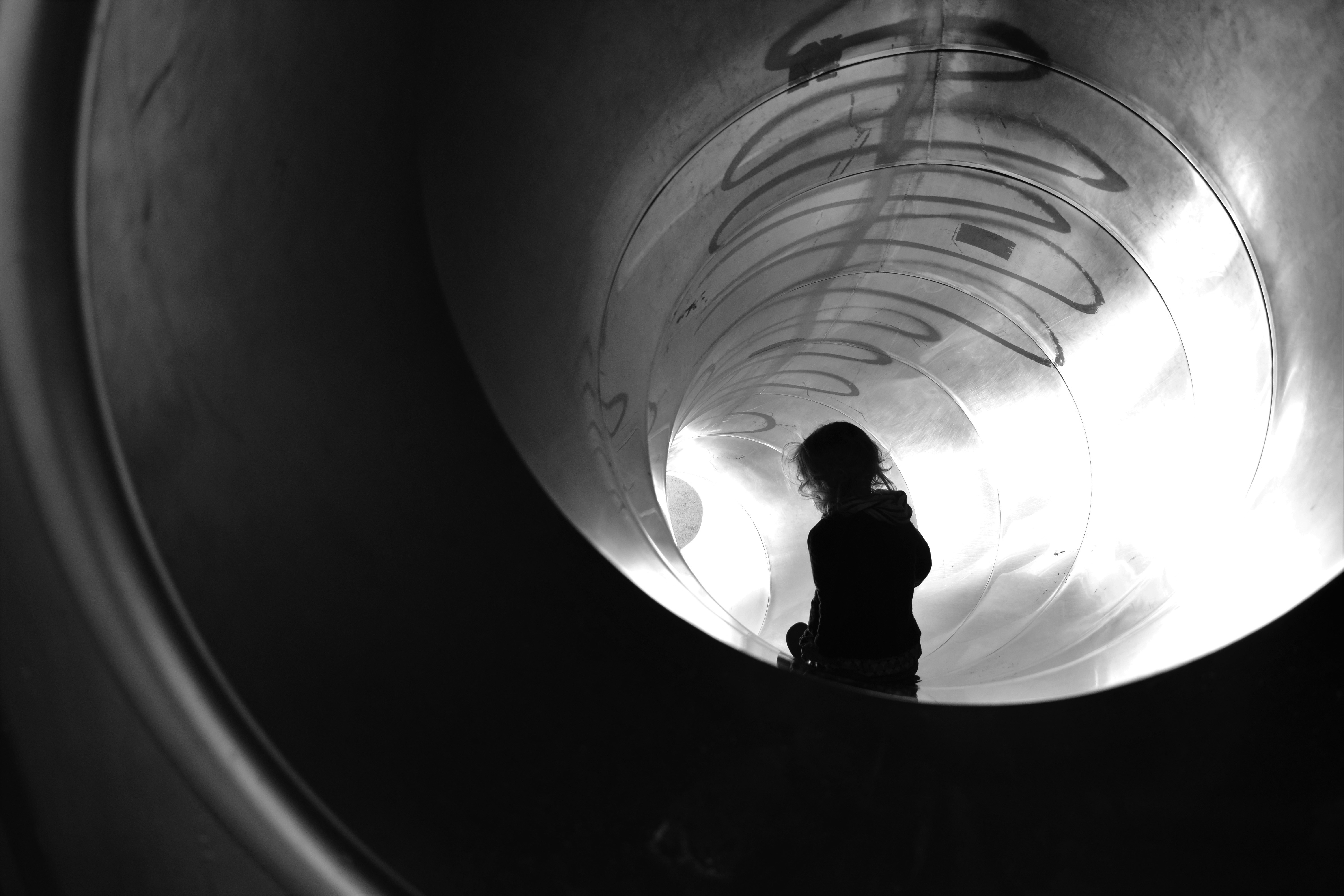 Silhouette at the Exit: A Figure Inside a Curved Tunnel