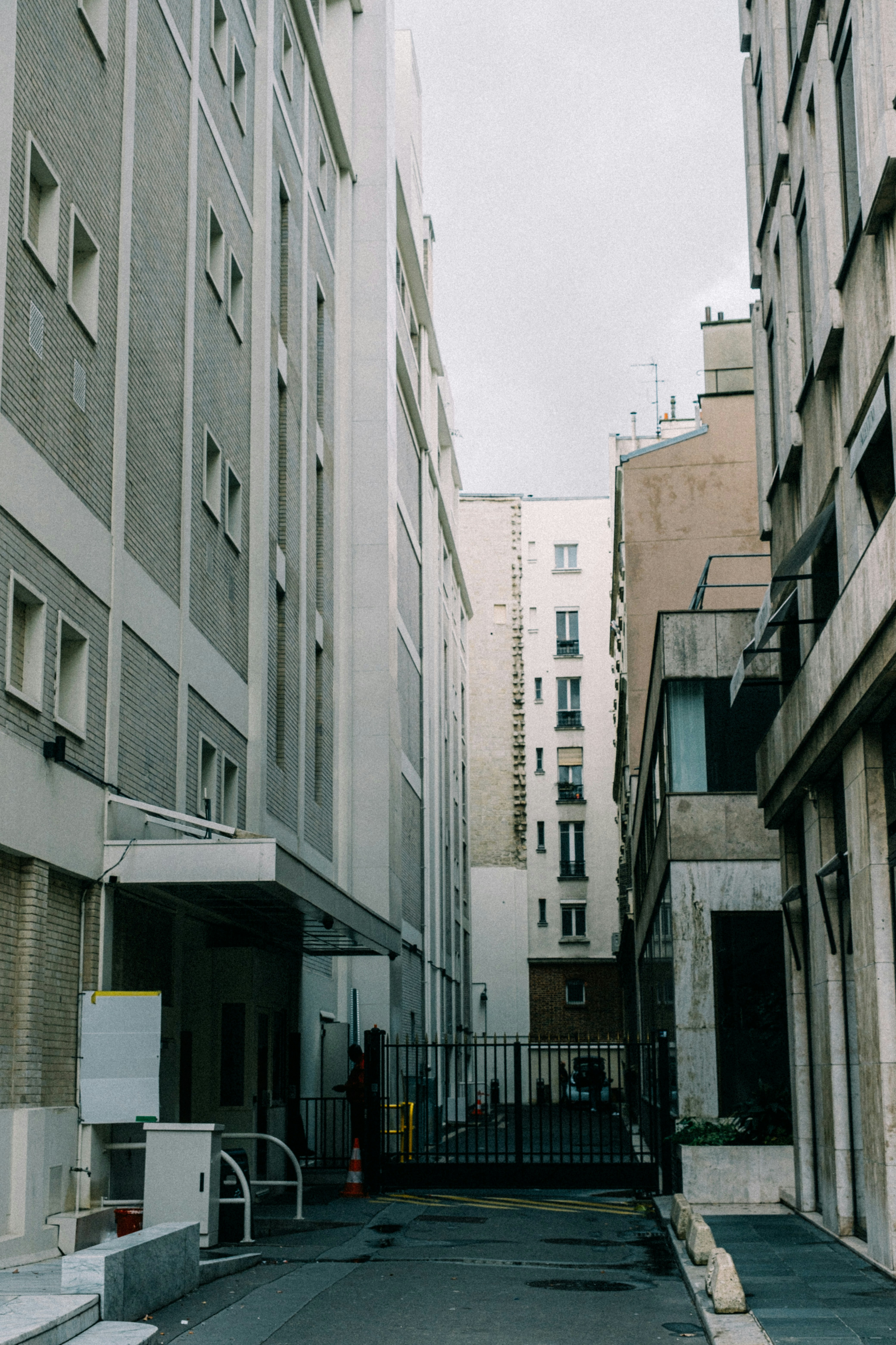 A narrow city street lined with tall buildings photo – Free Grey Image ...