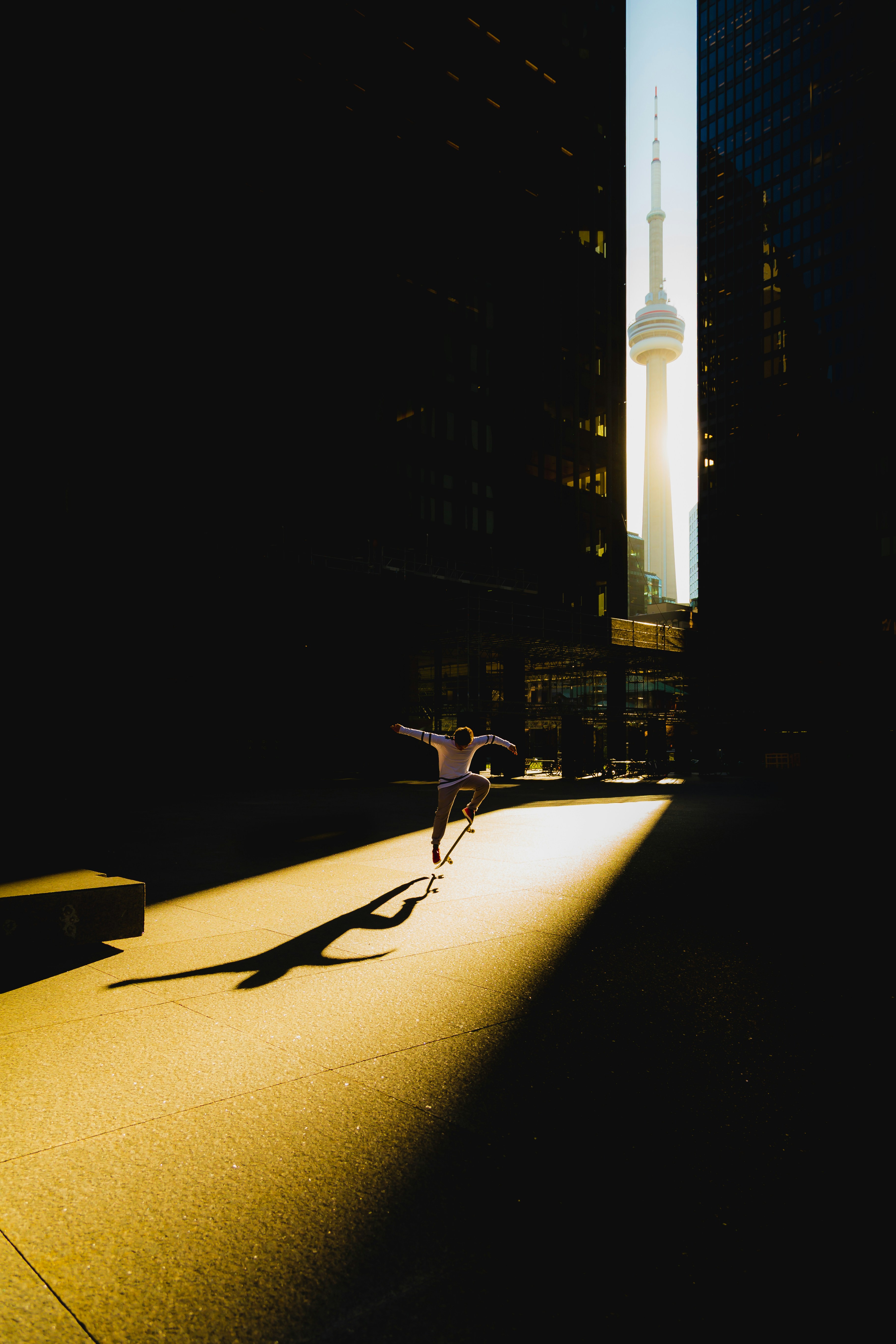 Solitary Skater in a Golden Beam Between Towers