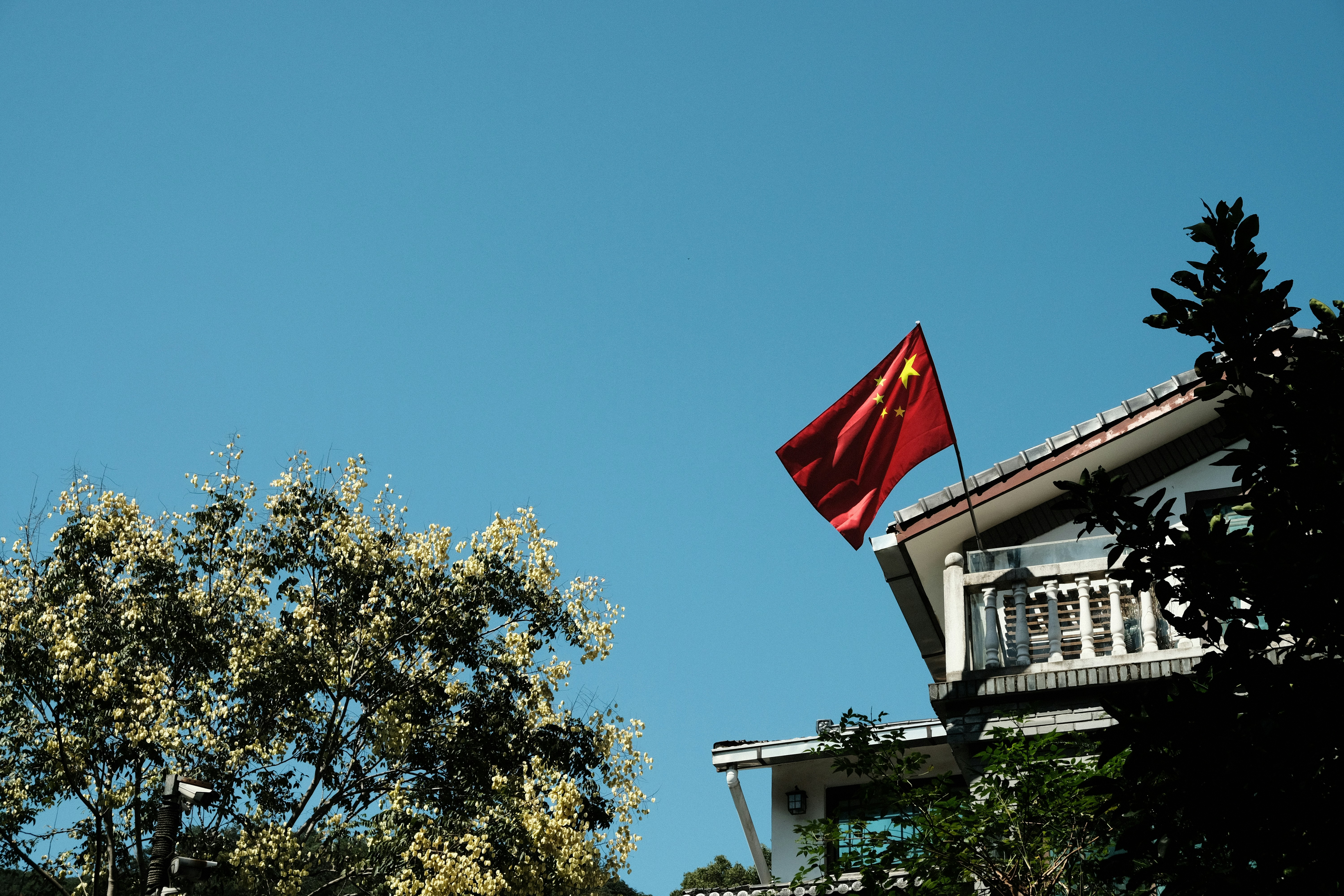 A chinese flag flying in front of a house photo – Free Hangzhou Image ...