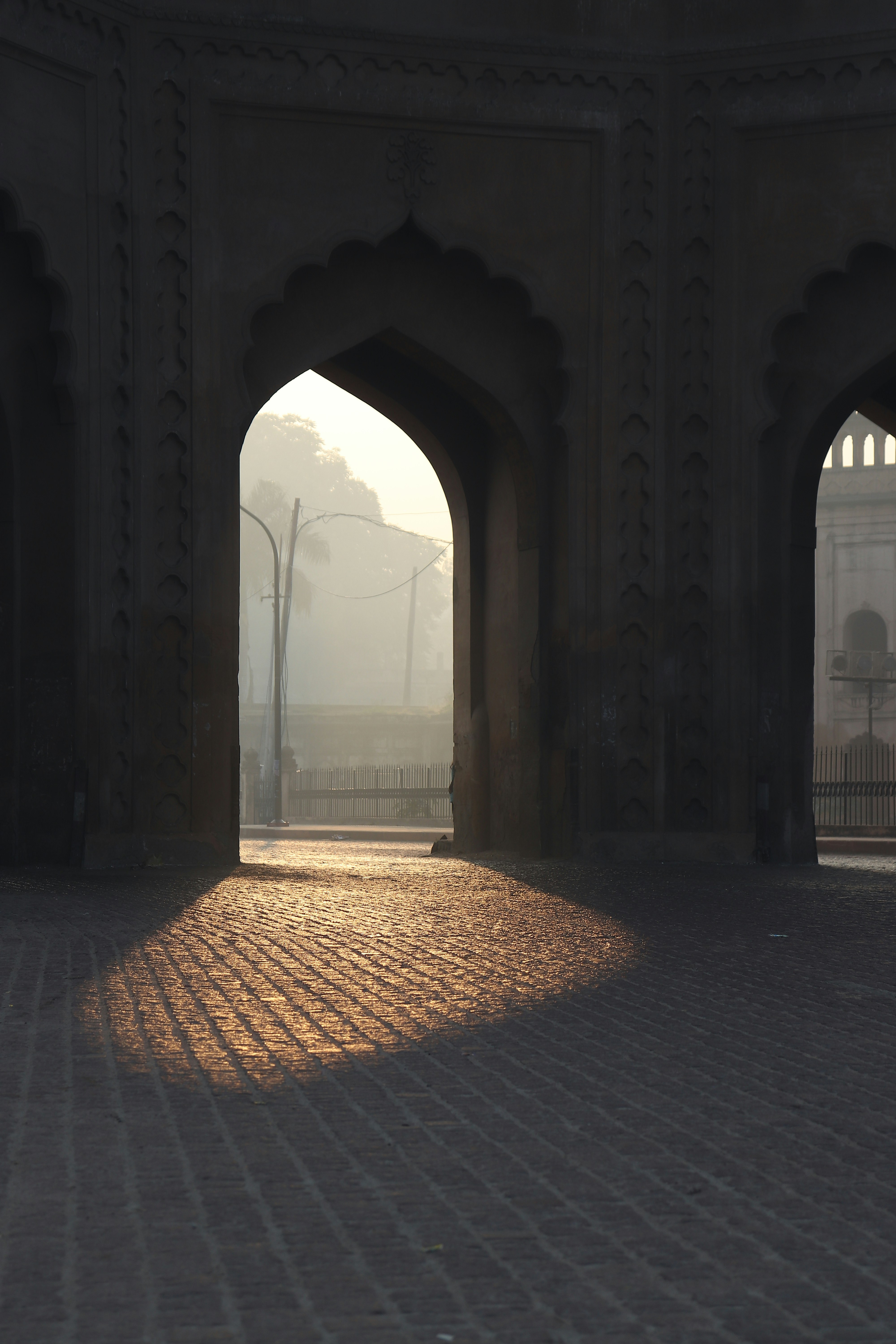 The sun is shining through the arches of a building photo – Free ...