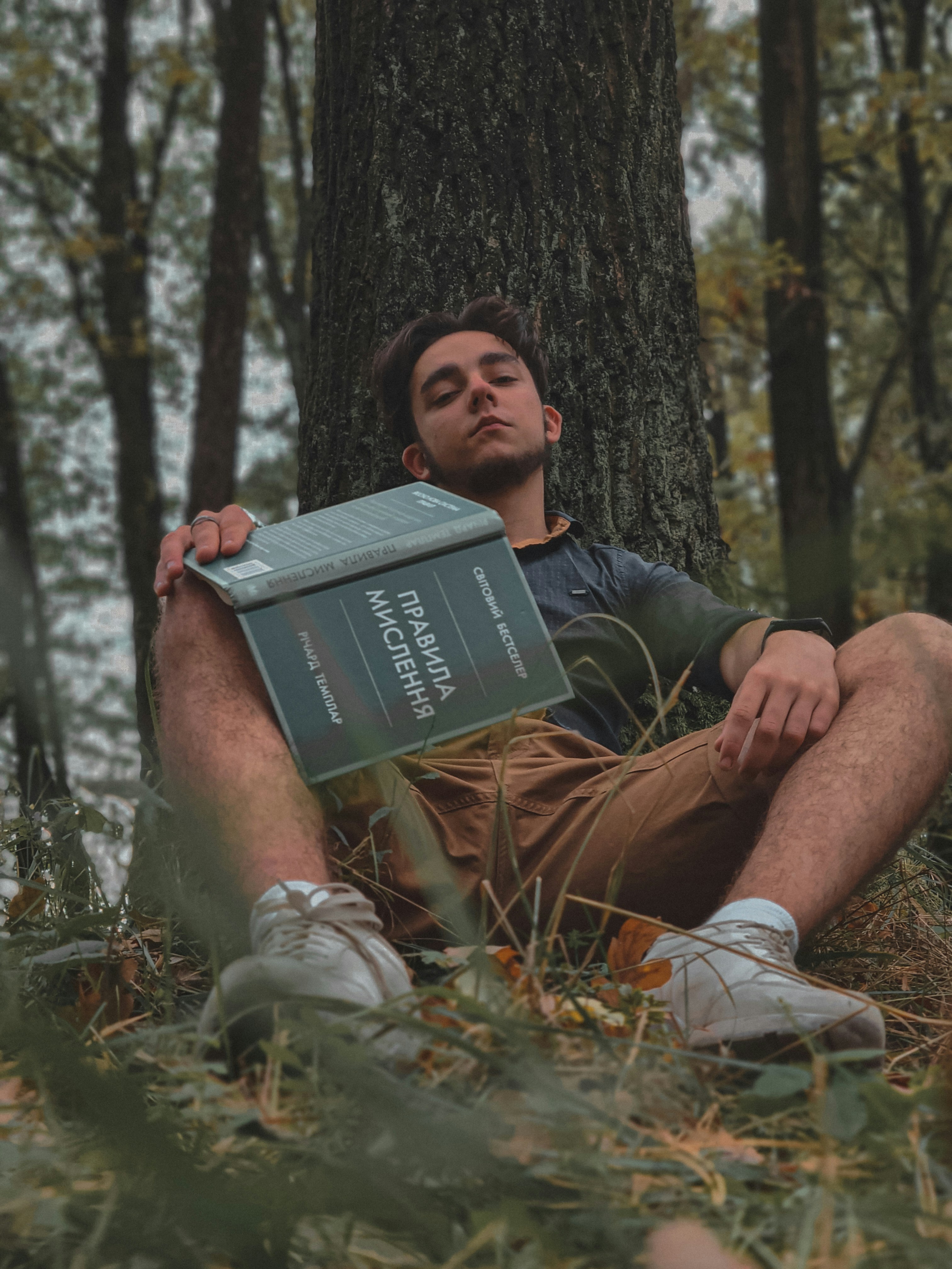 Forest Recline: A Quiet Moment with a Teal Cyrillic Box