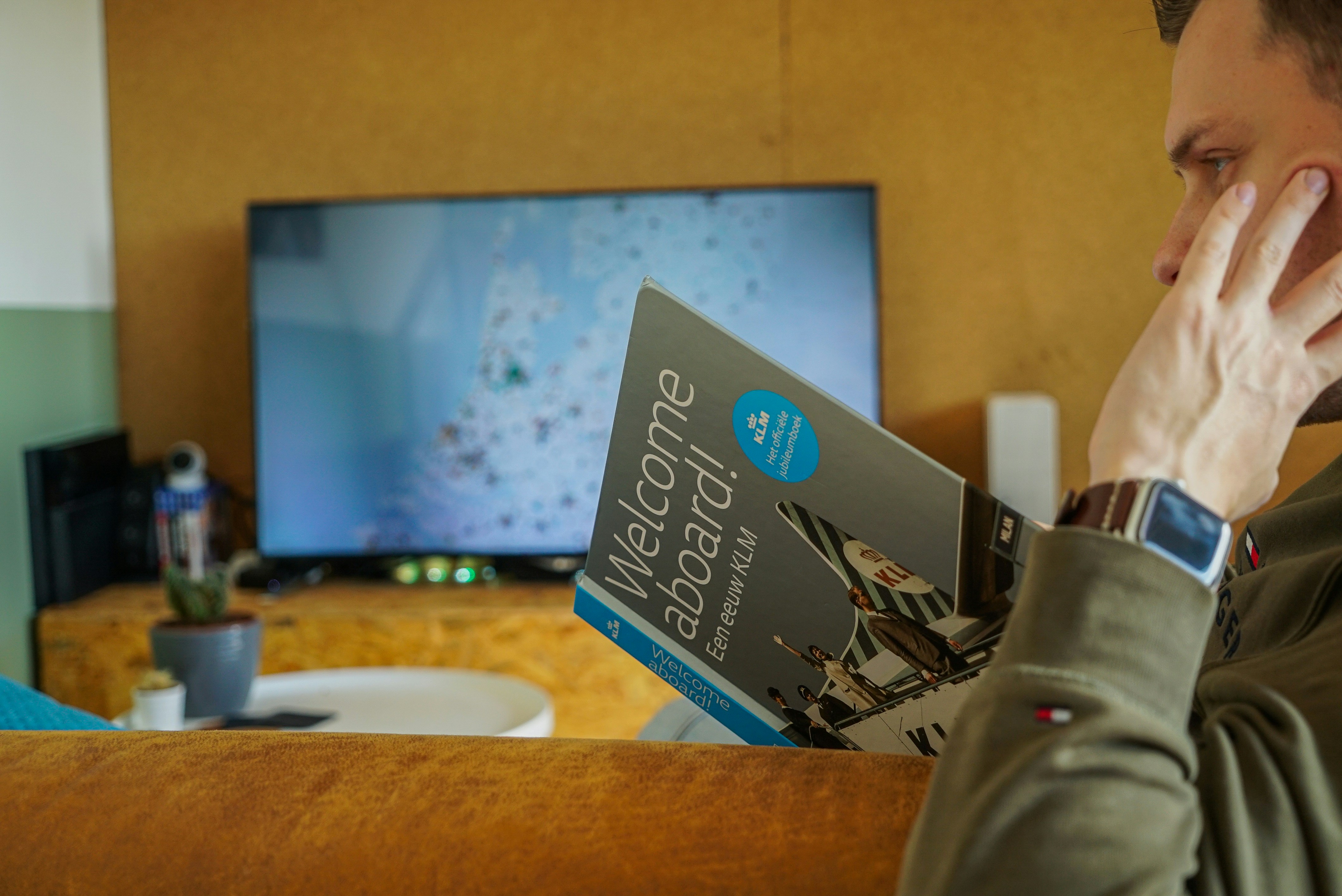 Welcome Aboard: Reading a Travel Brochure on a Cozy Sofa