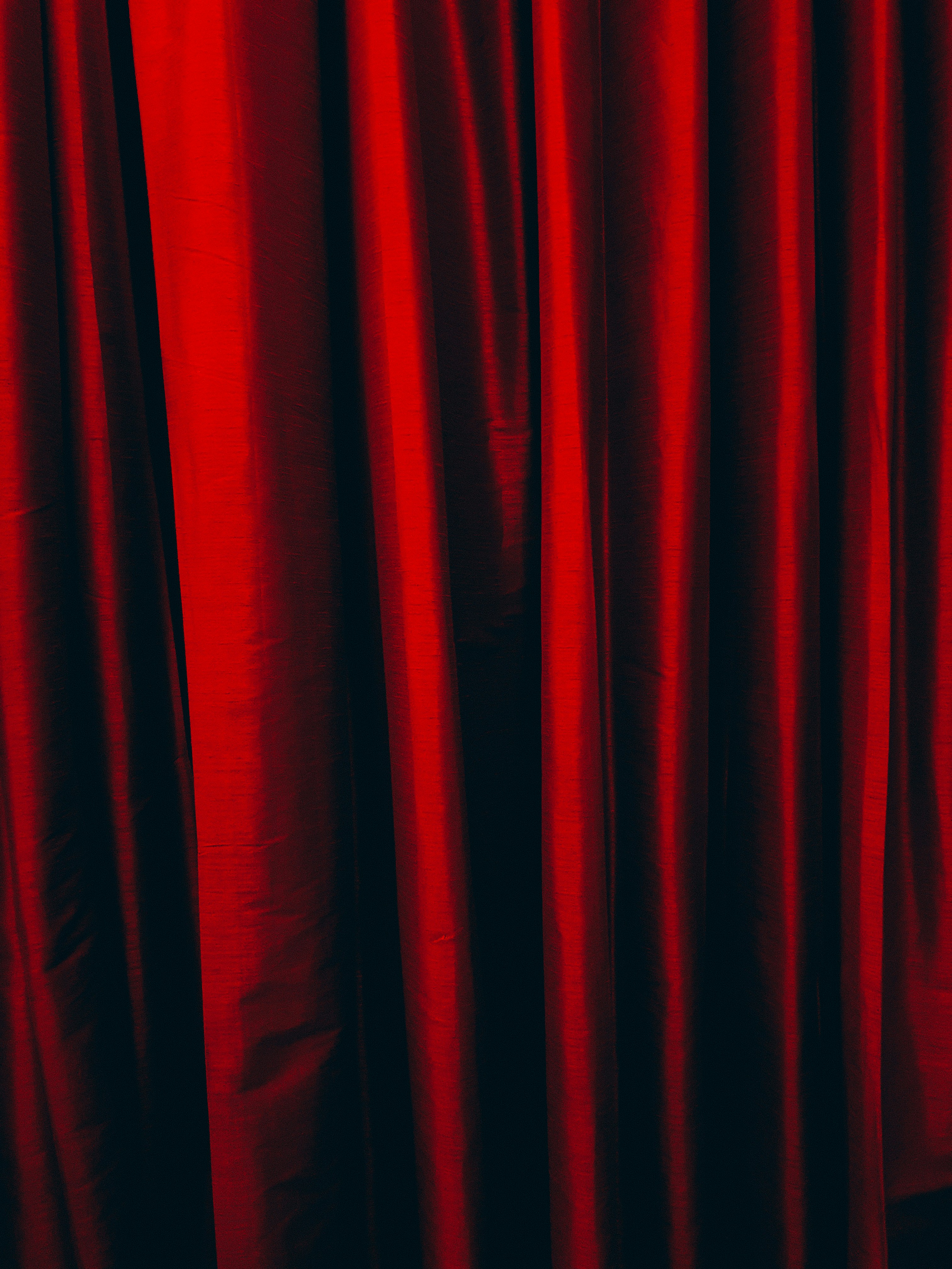 A close up of a red curtain with a black background photo – Free ...
