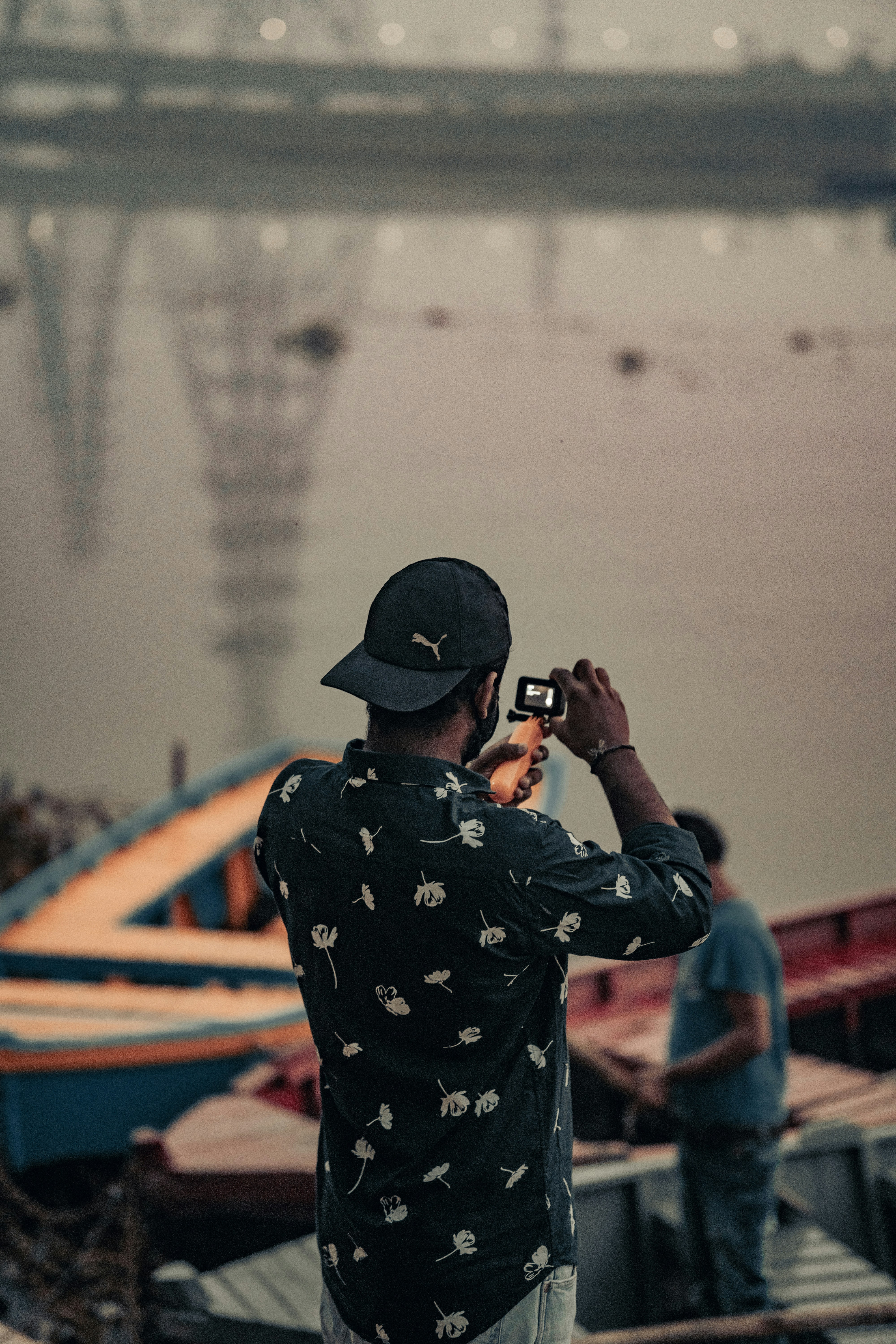 Traveler with a Tall Hat Capturing a Moment by the Quiet Shore