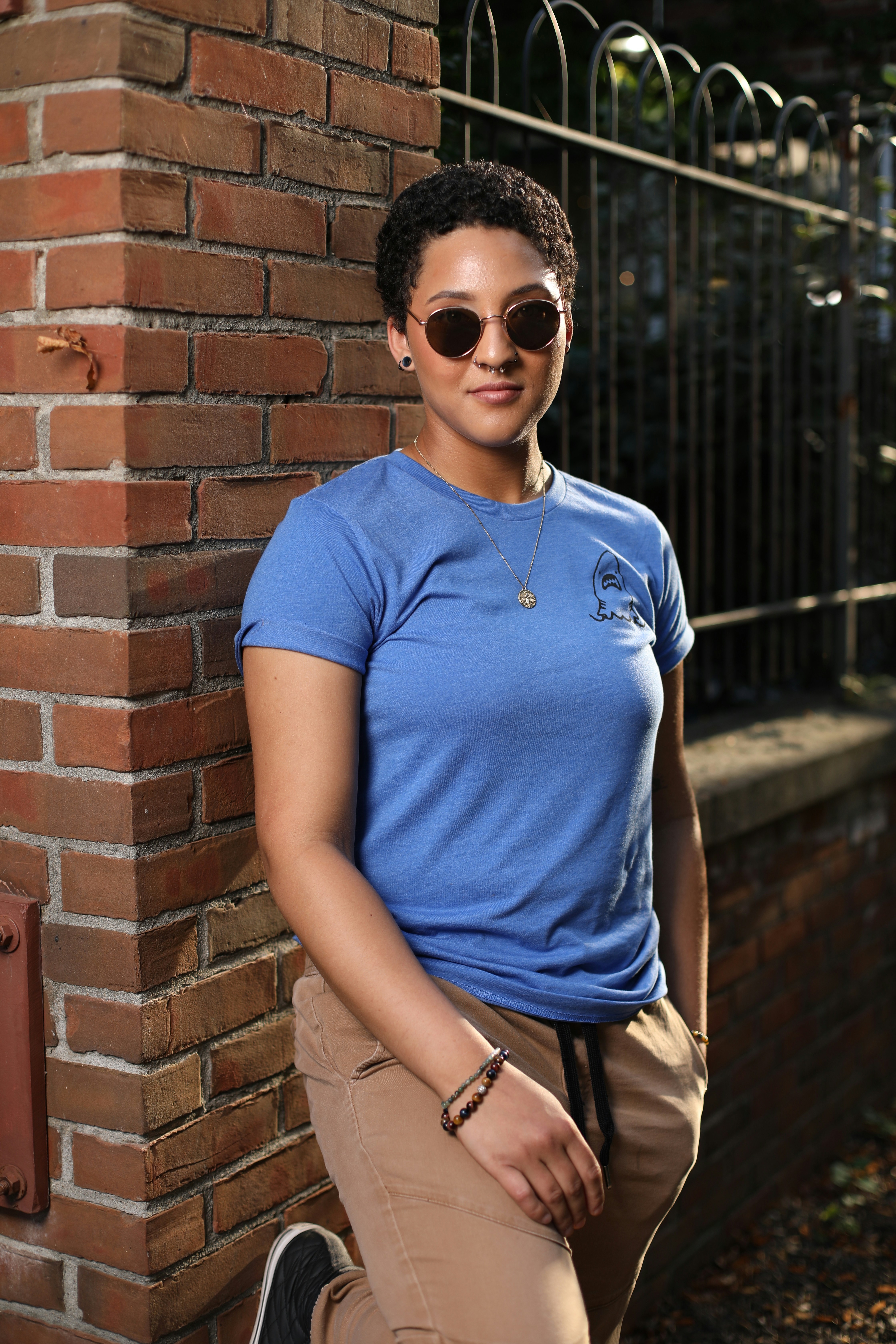A woman standing next to a brick wall photo – Free Human Image on Unsplash