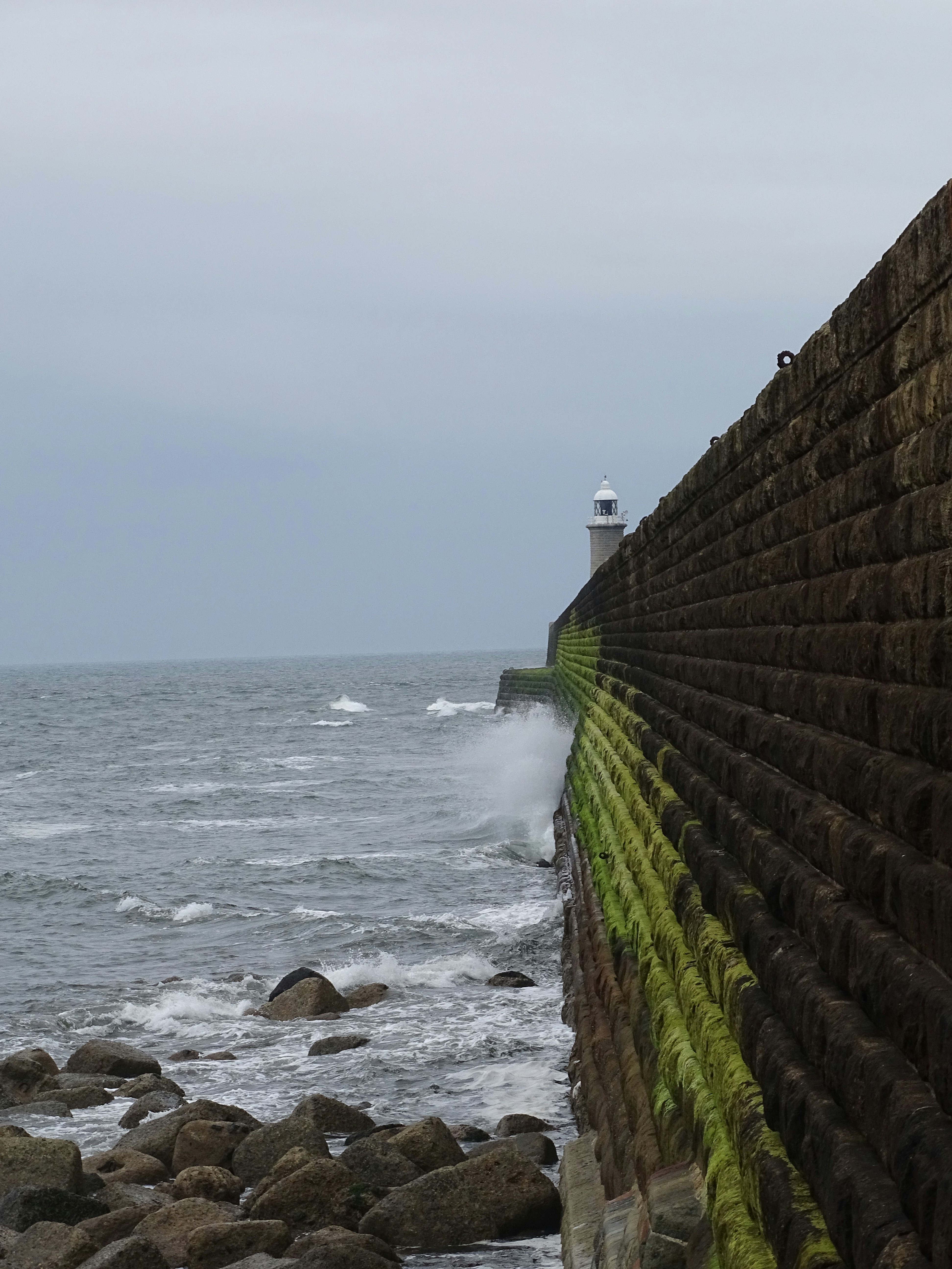 Waves crashing against Tynemouth Pier Lighthouse.