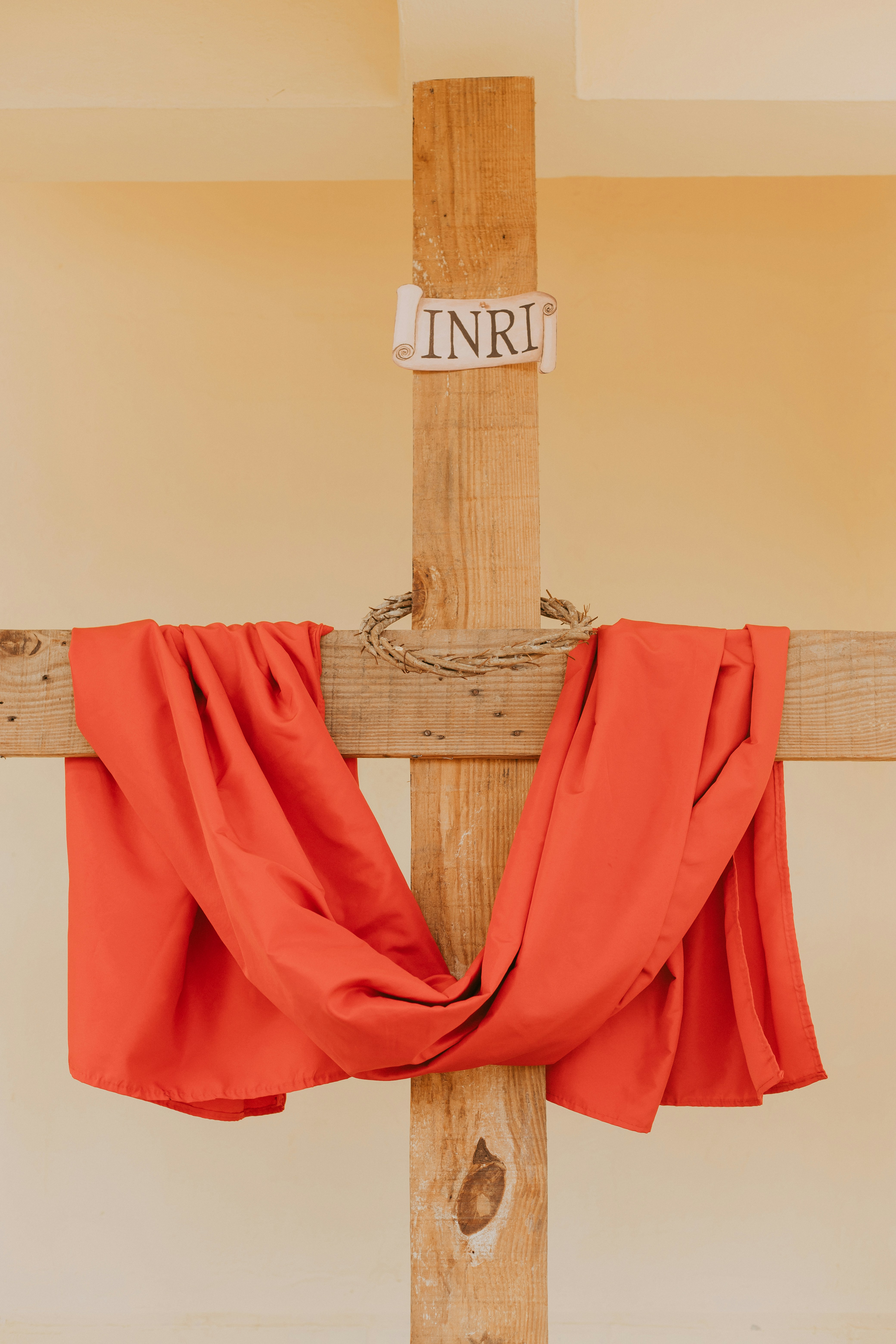 A cross with a red cloth draped around it photo – Free Clothing Image ...