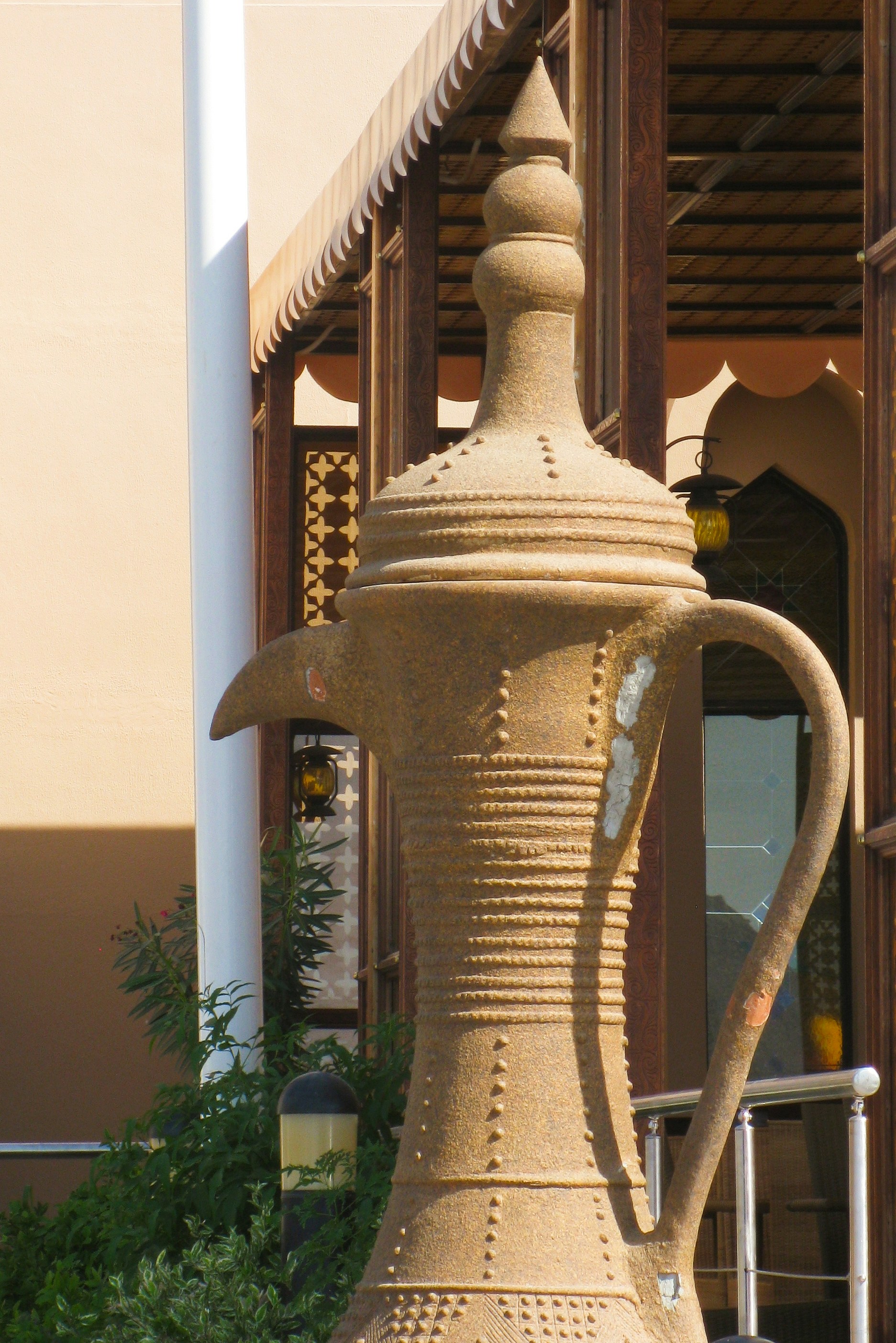 a large vase sitting outside of a building