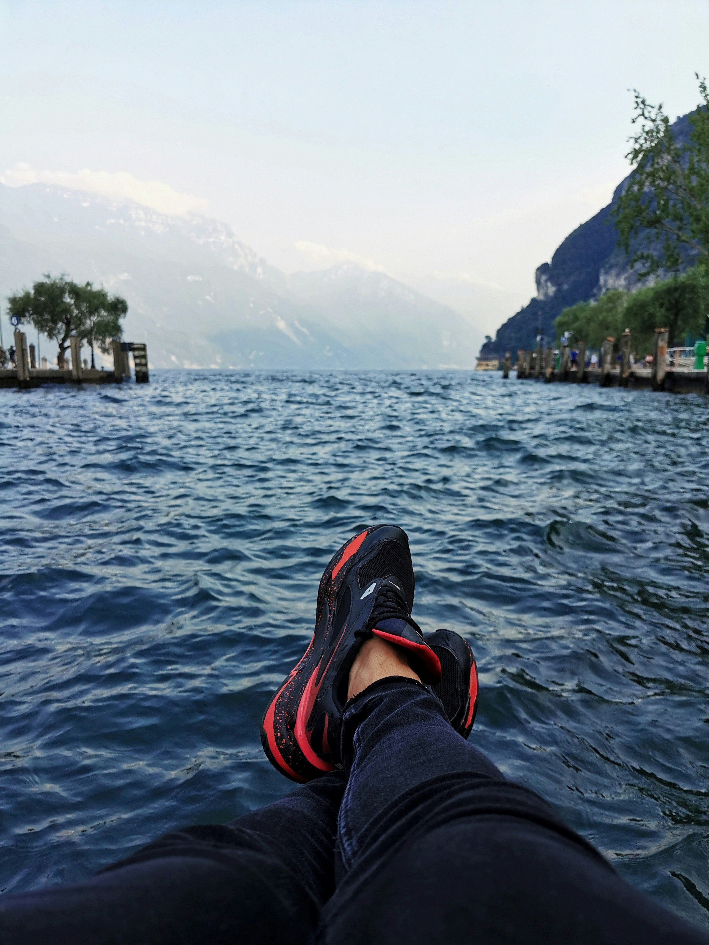 Feet Over a Lake: A Quiet Moment on a Mountain Pier
