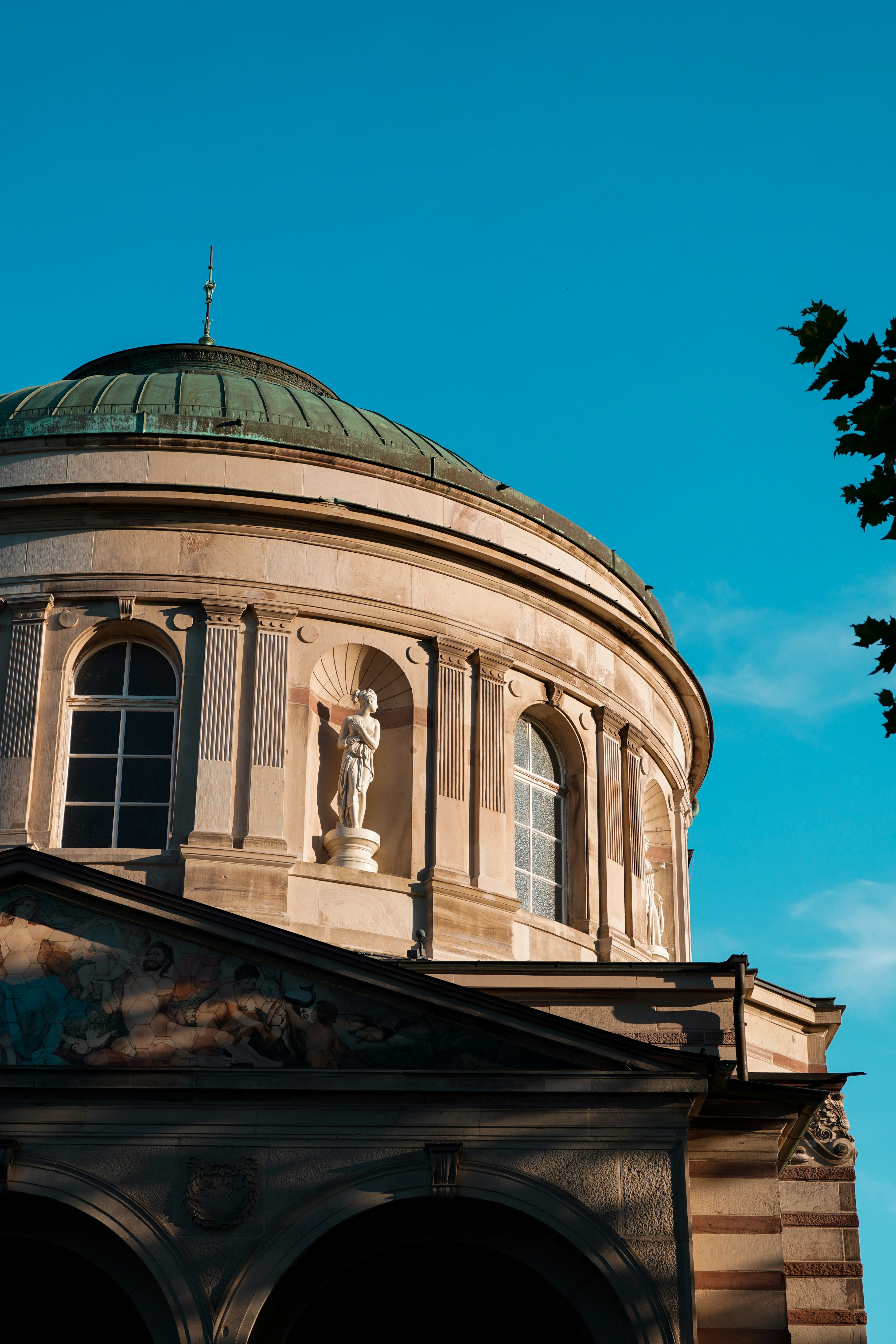 A building with a statue on top of it photo – Free Building Image on ...