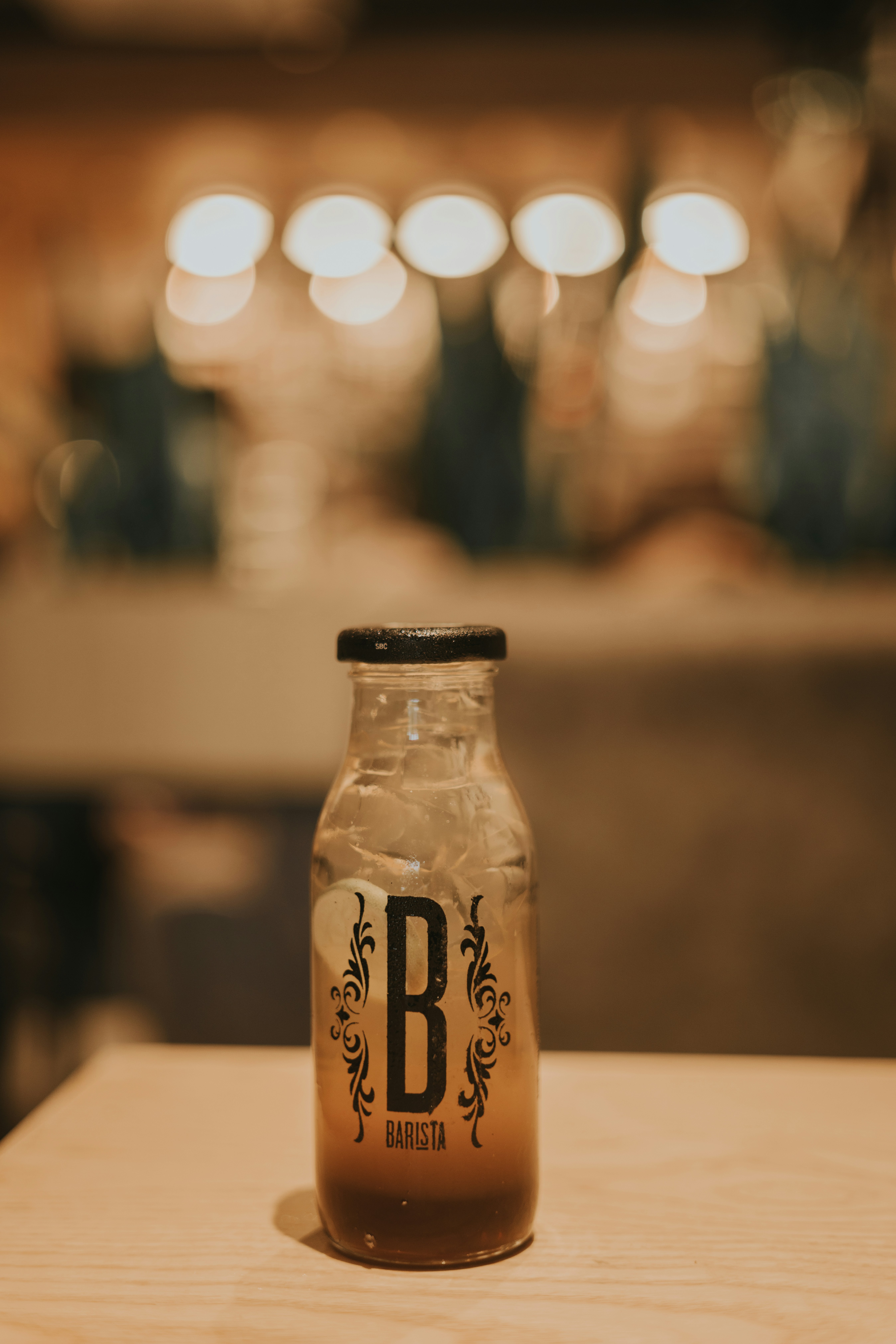 a bottle of beer sitting on top of a wooden table
