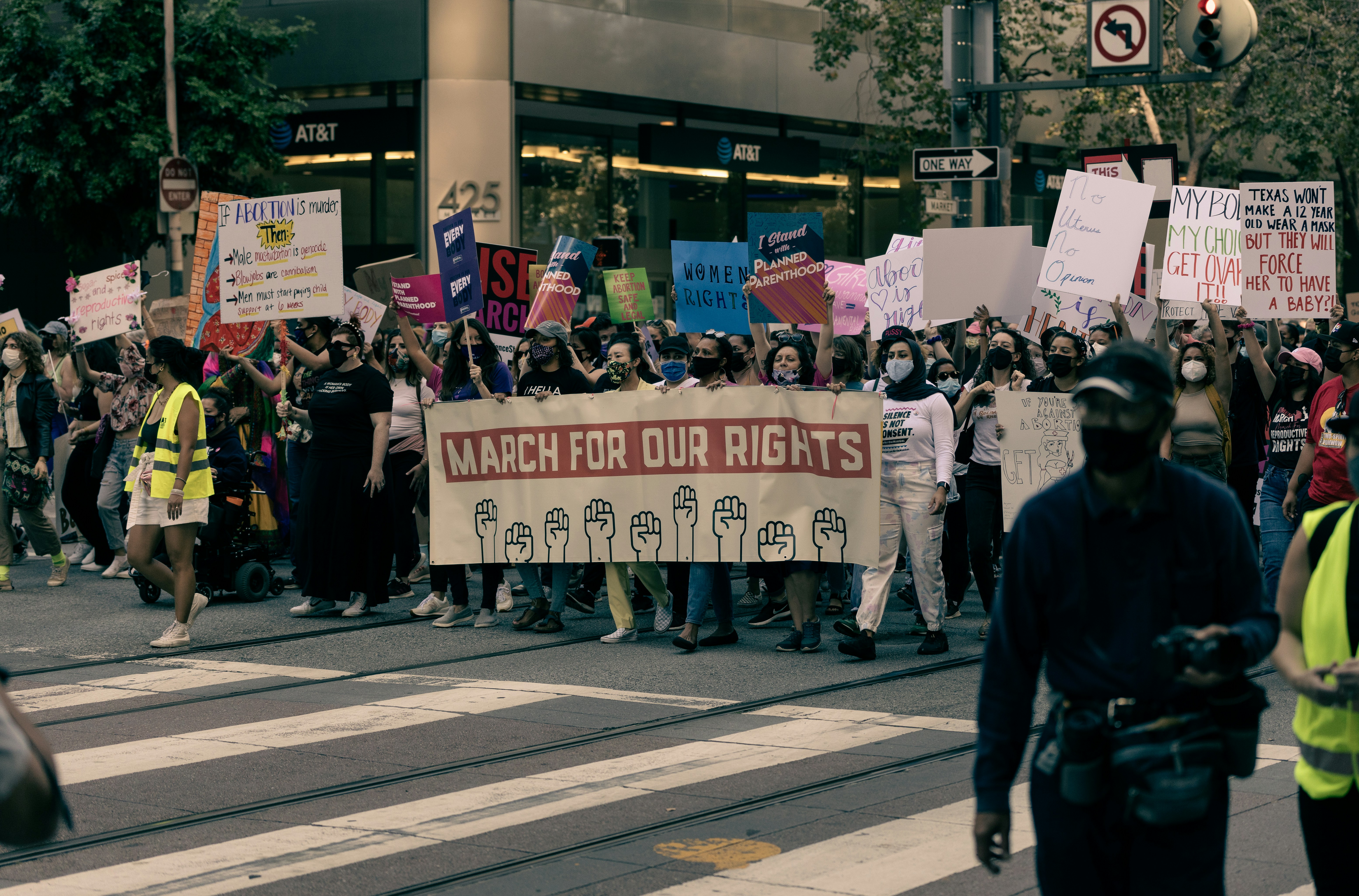 A large group of people marching down a street photo – Free San ...