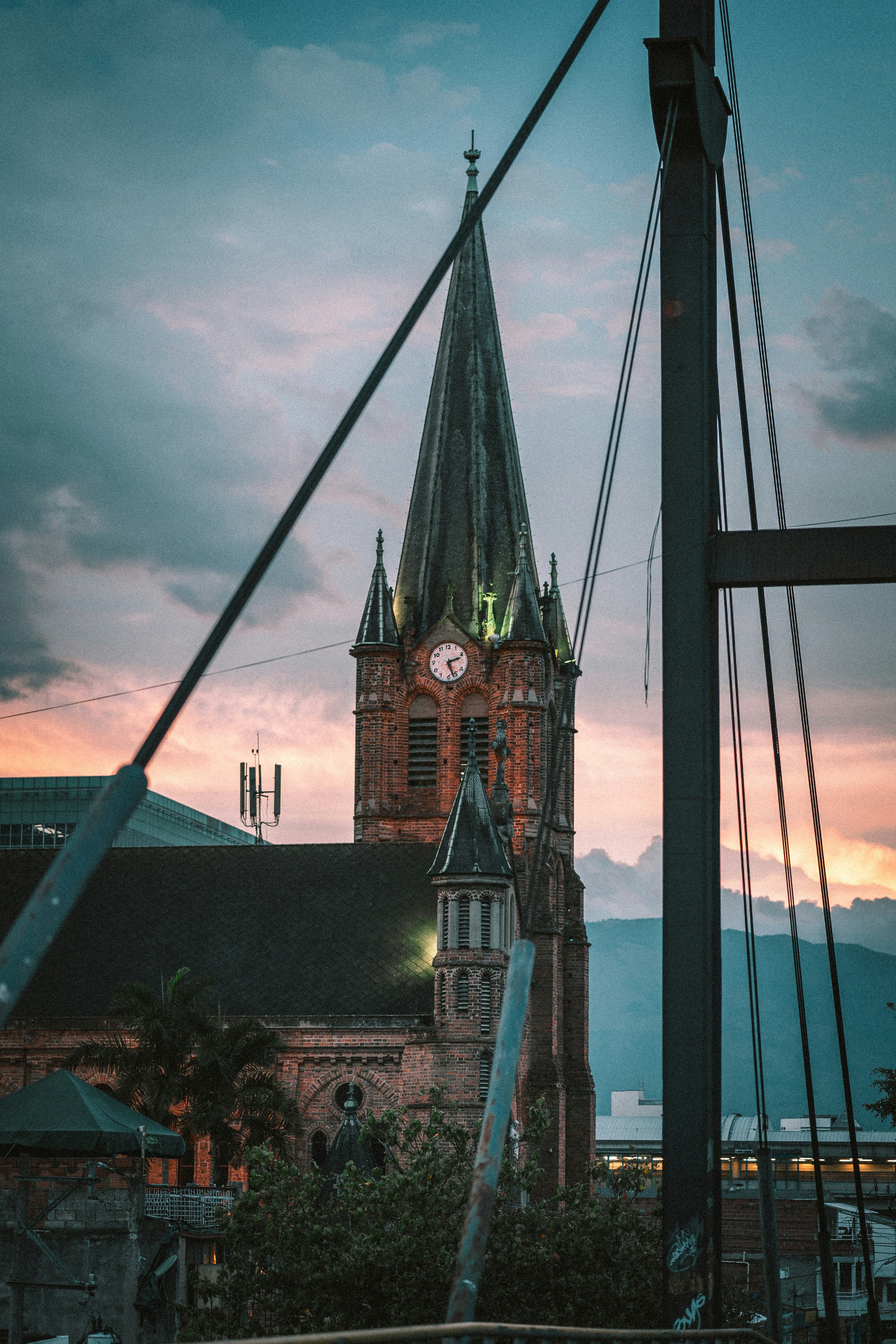 Church tower in Medellín, Colombia | a tall clock tower towering over a city