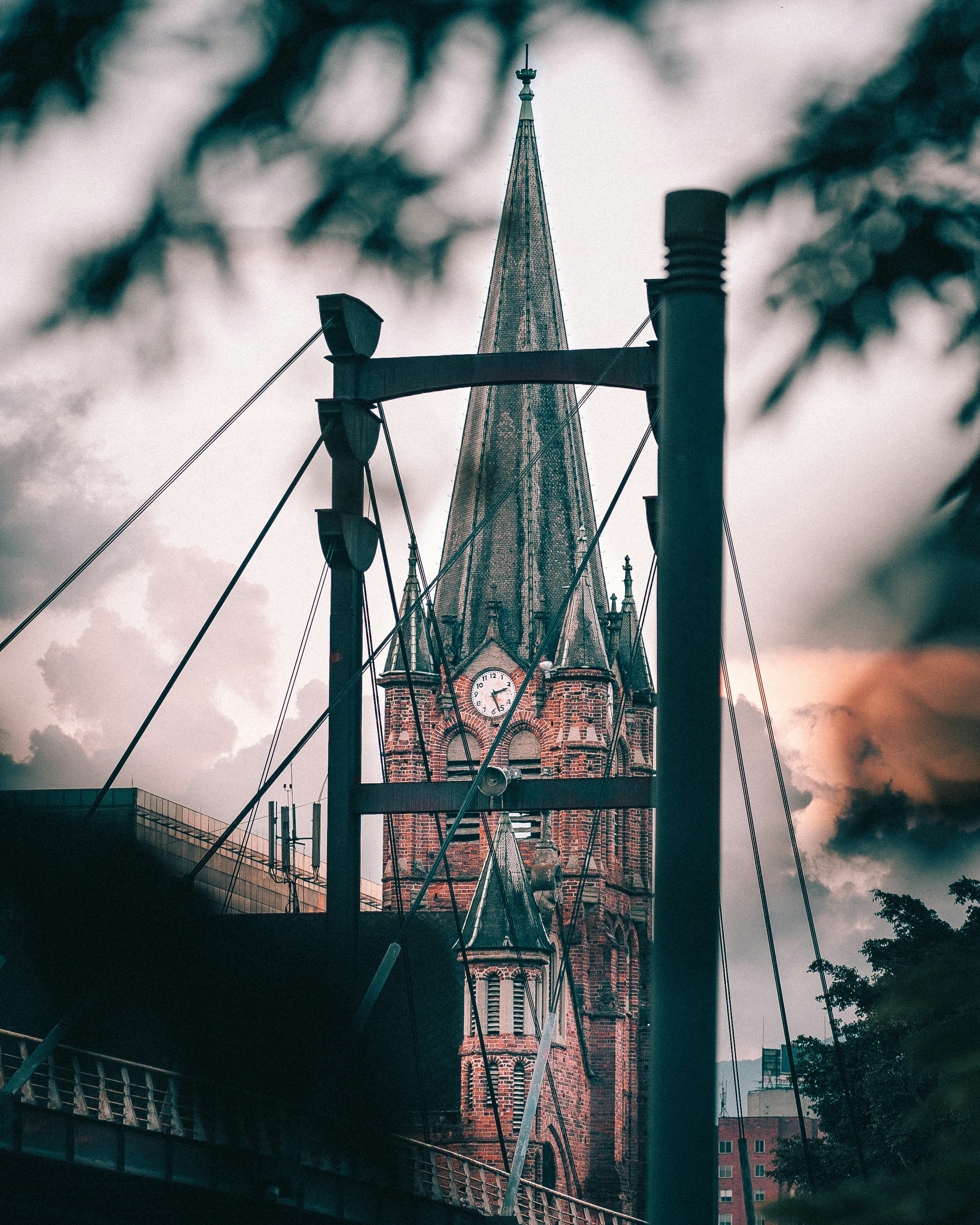 Church tower in Medellín, Colombia | a tall clock tower towering over a city