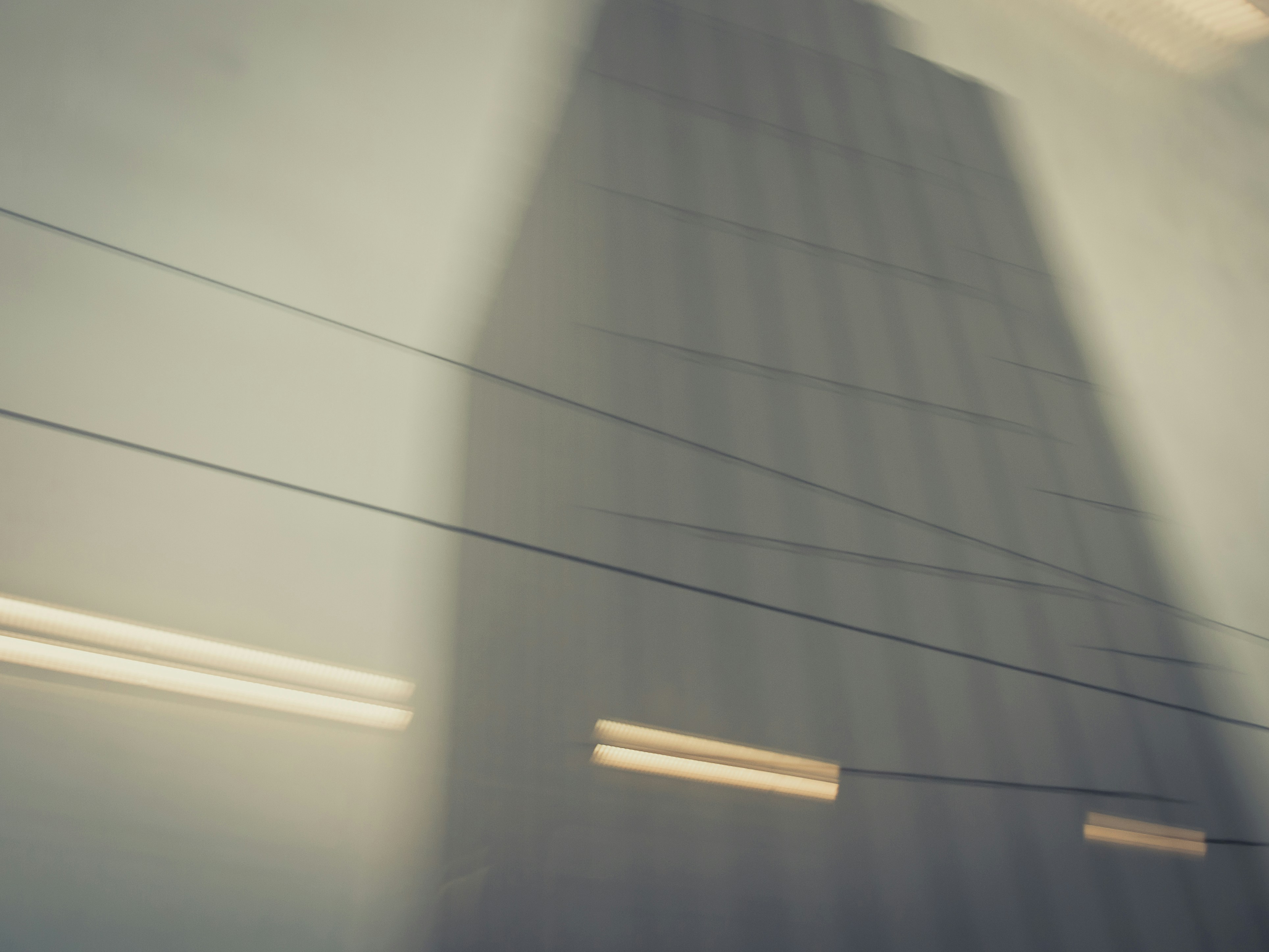A blurry photo of a building and power lines photo – Free Image on Unsplash
