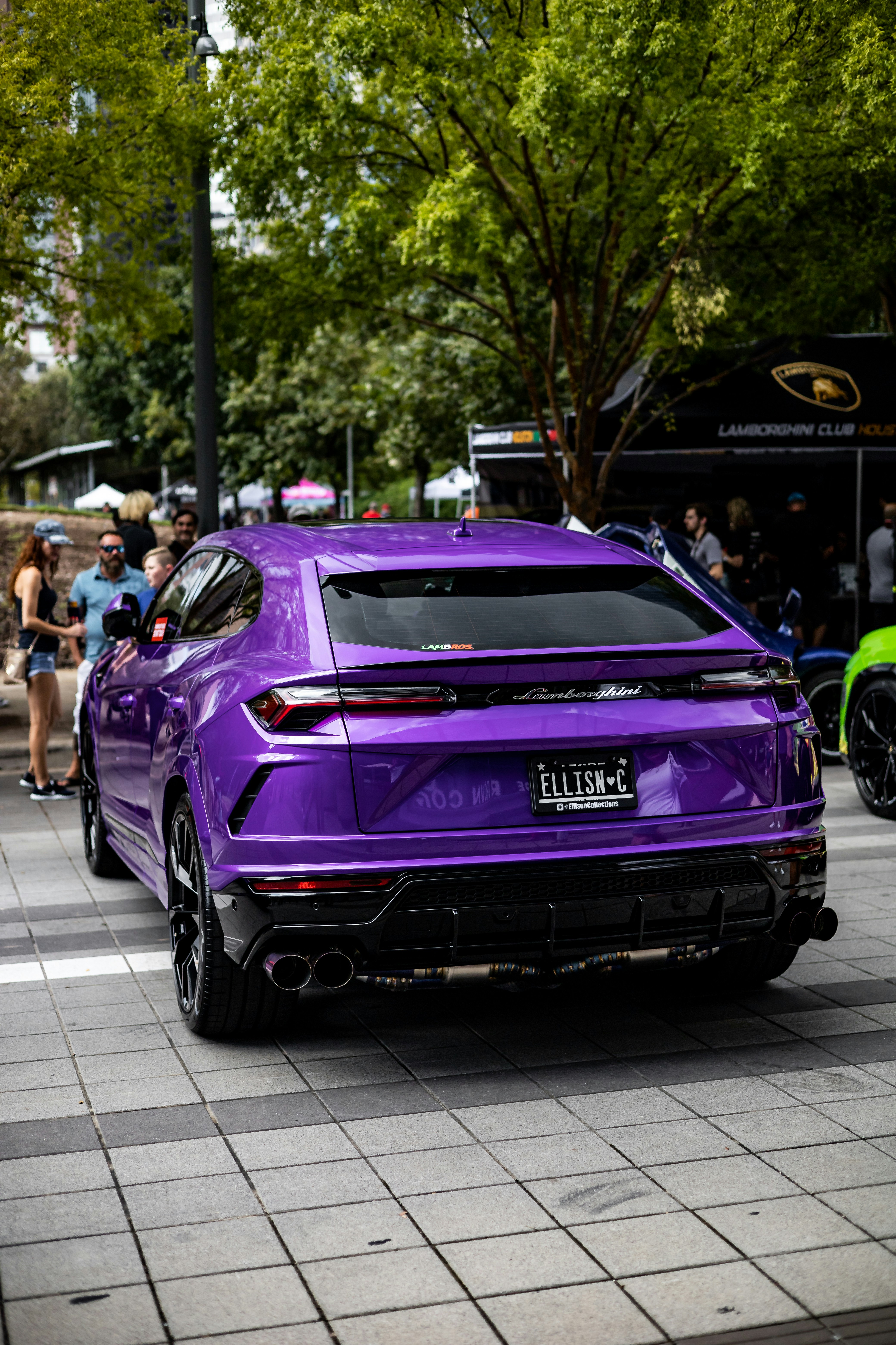 Violet Vantage: Rear-View of a Lamborghini Urus at a City Car Show