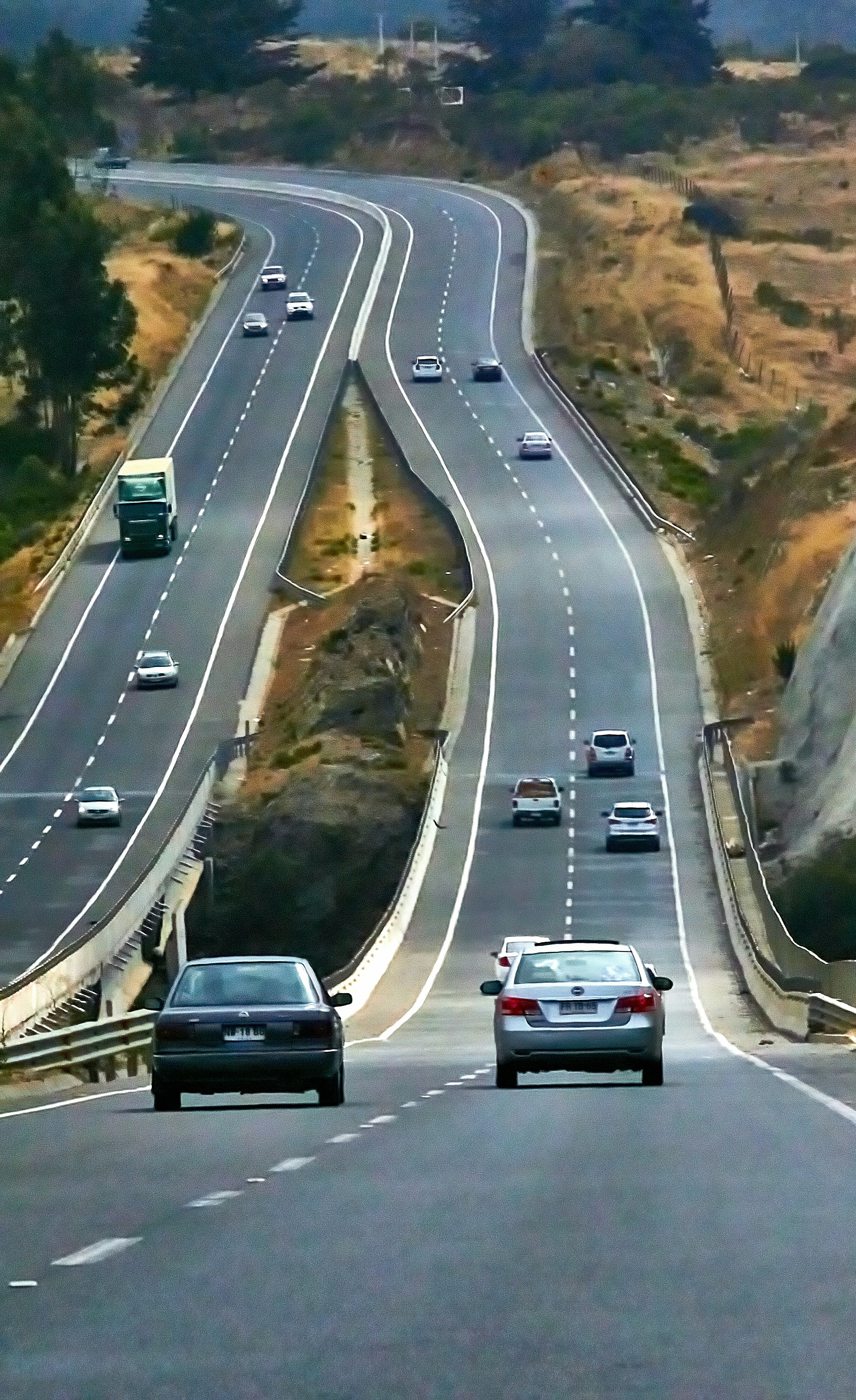 Two Lanes, One River of Asphalt: Aerial Drive Through a Winding Highway