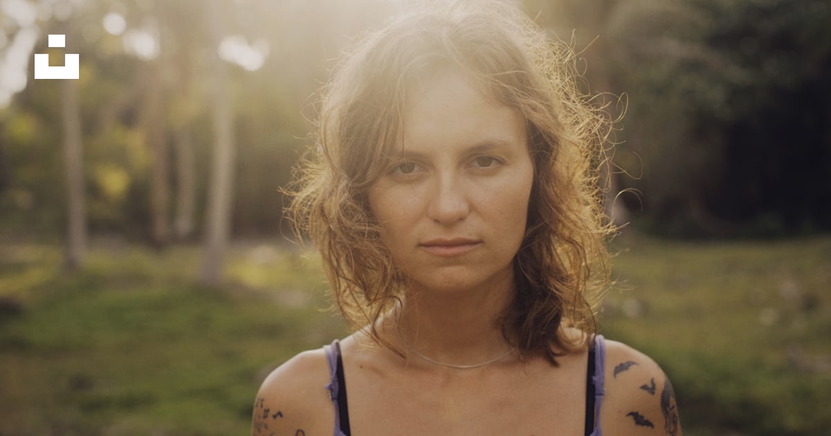 A Woman With A Tattoo On Her Arm Photo Free Face Image On Unsplash