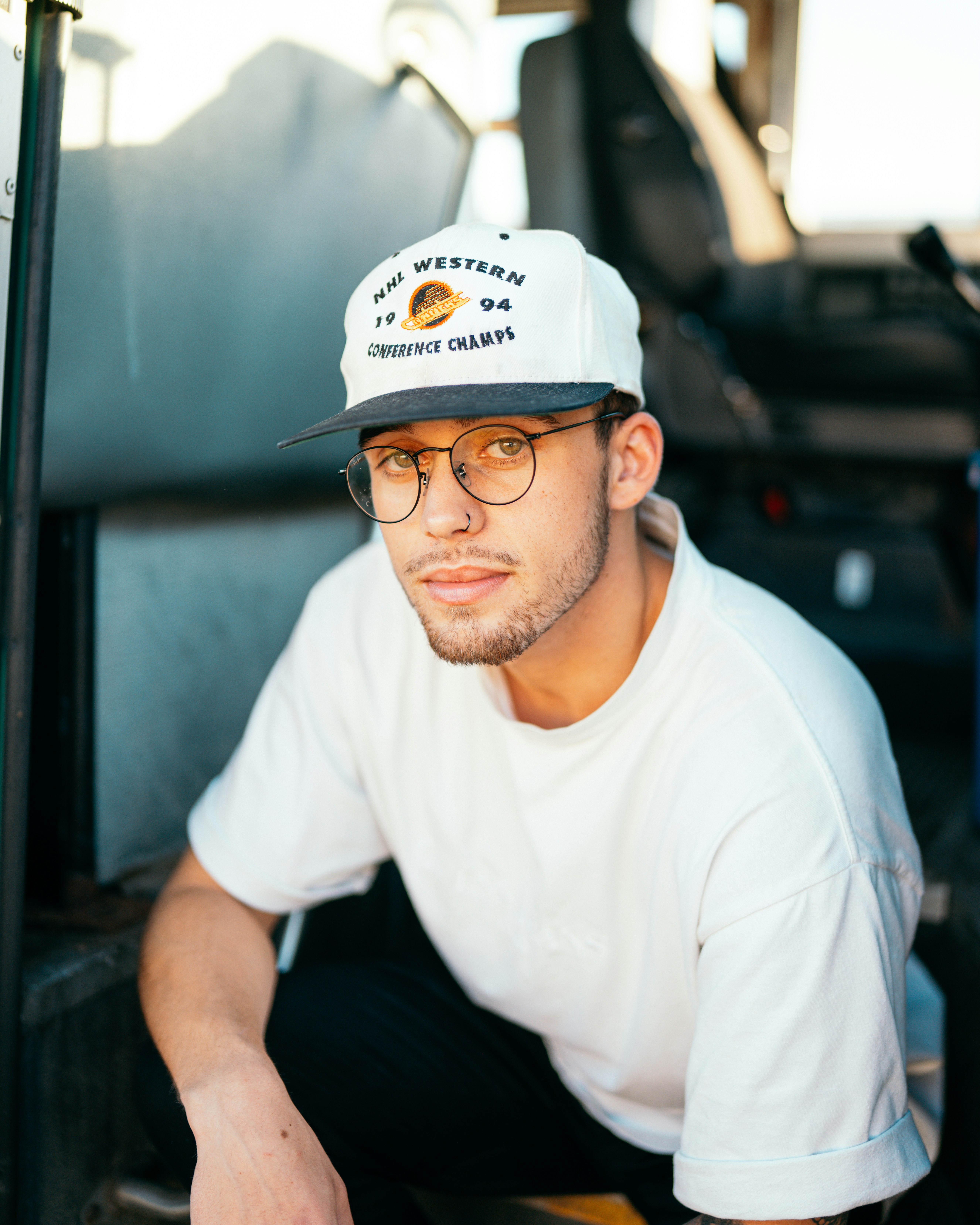 Portrait in a Sunlit Cabin: Quiet Confidence Under a White Cap