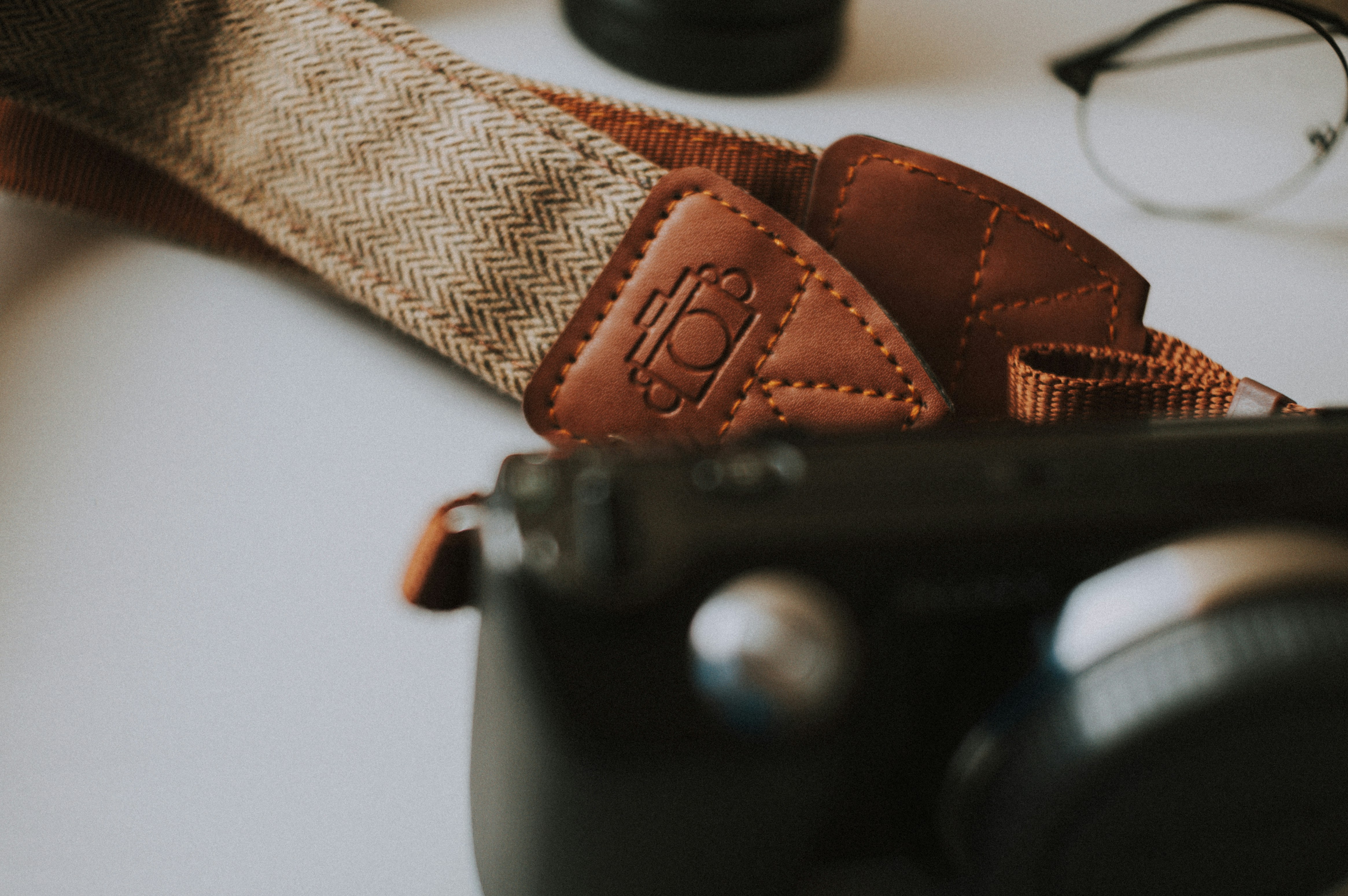 Herringbone Strap Framing a Close-Up of a Leather Patch on a Compact Camera
