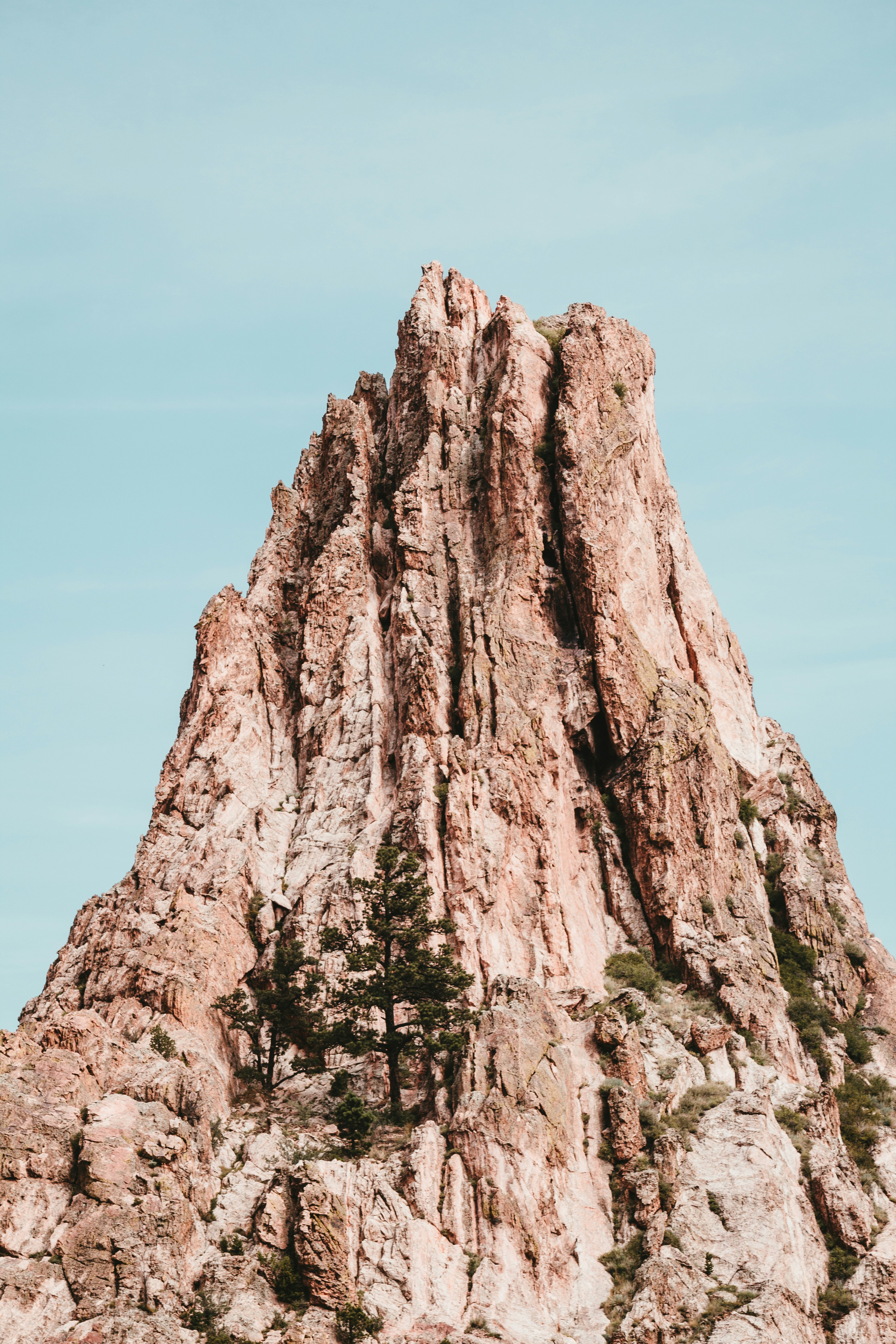 Granite Sentinel: A Jagged Peak Reaching Toward A Clear Sky