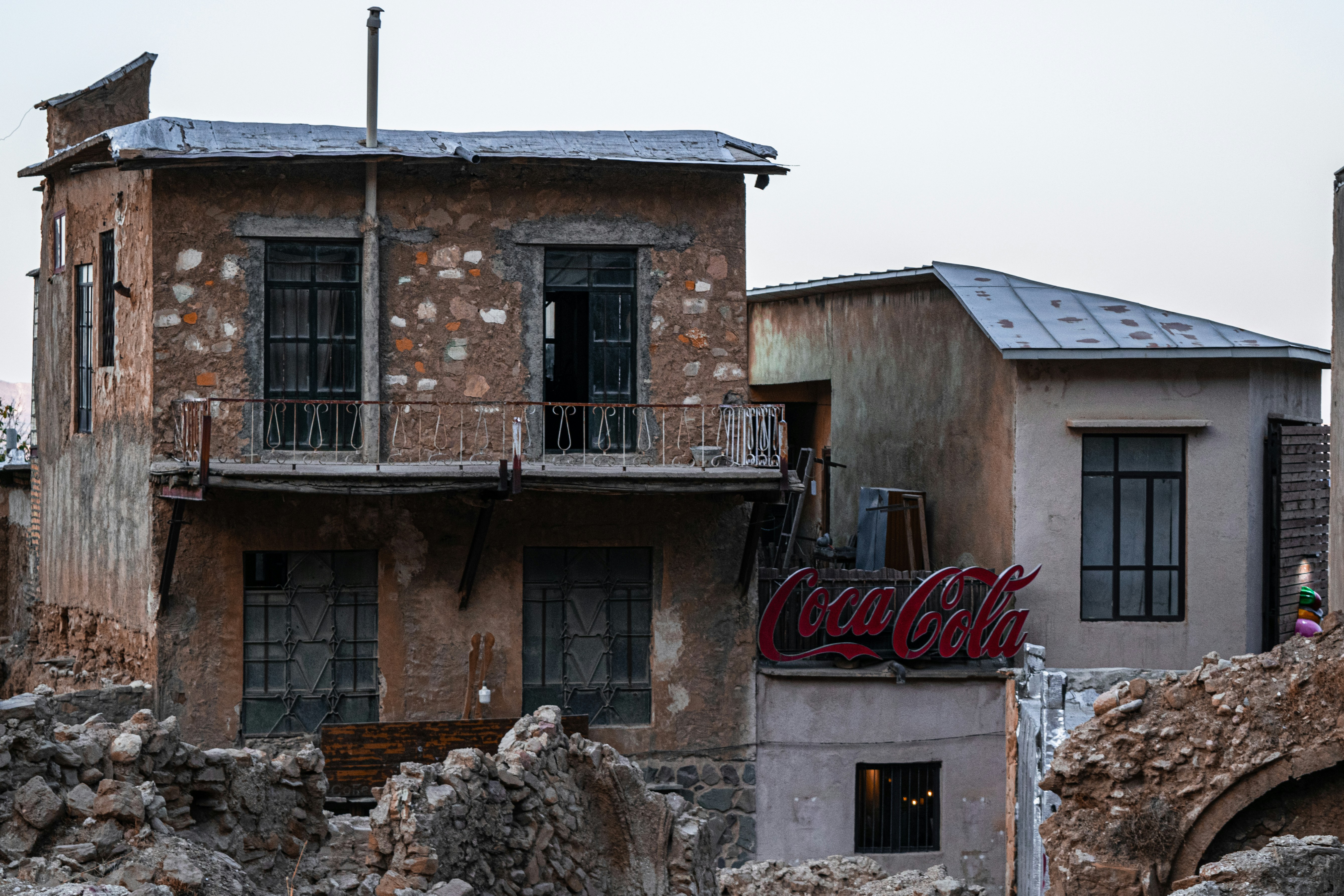 An old building with a coca cola sign on it photo – Free Ghalat Image ...