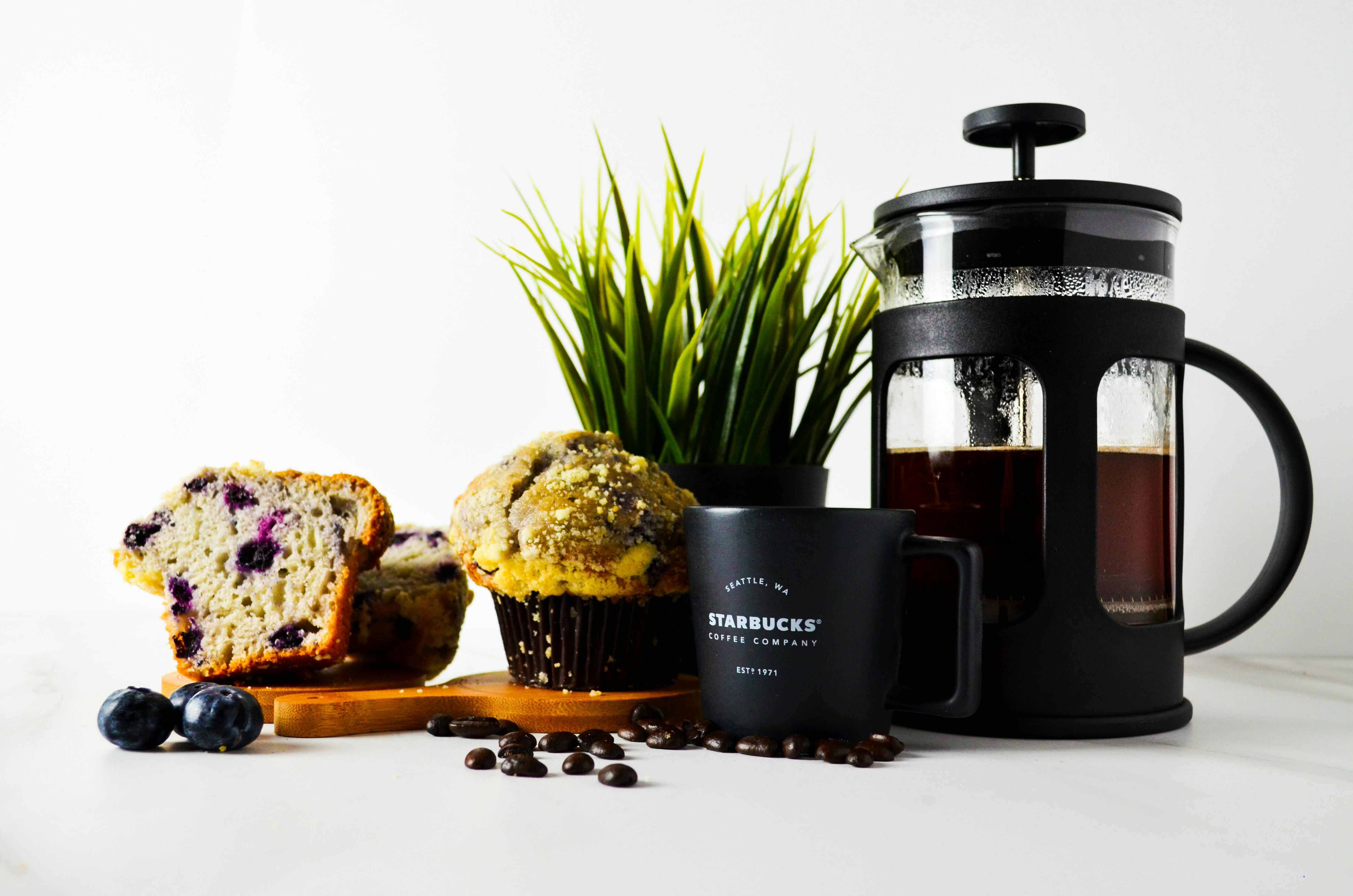 a cup of coffee and some muffins on a table