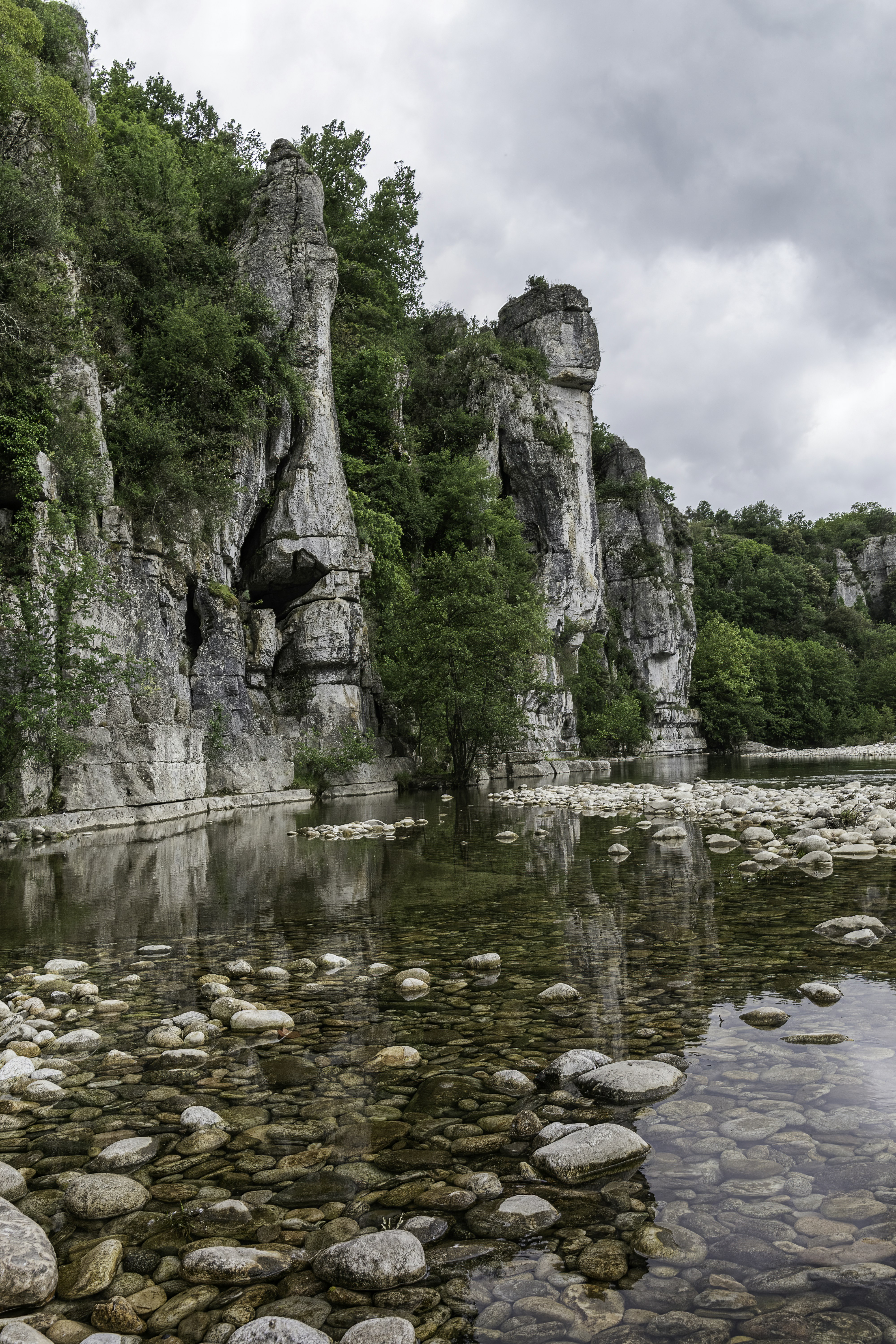 Stone sentinels along a glassy river